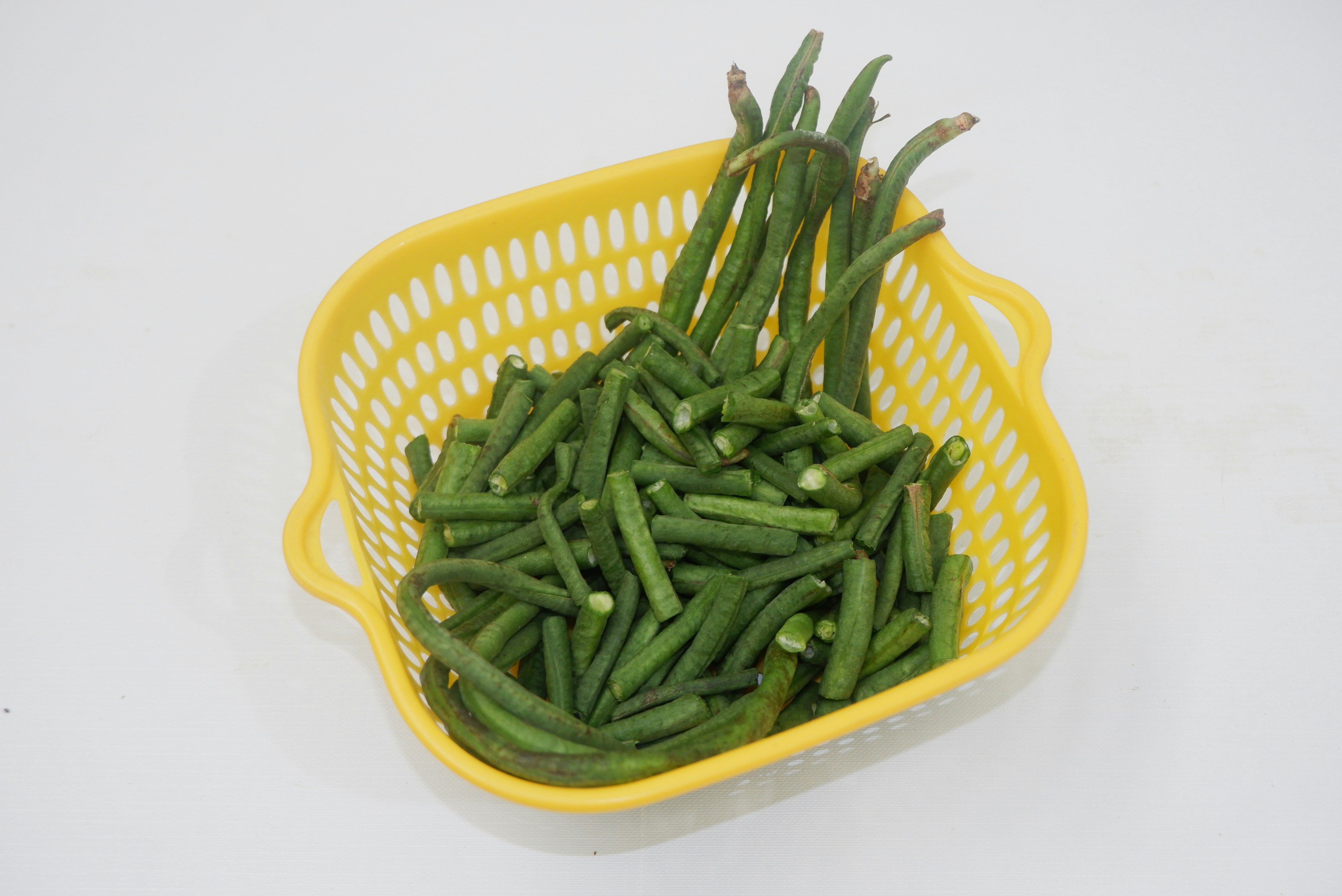 Basket of Crisp Green Beans: Bright Harvest in a Yellow Perforated Bowl