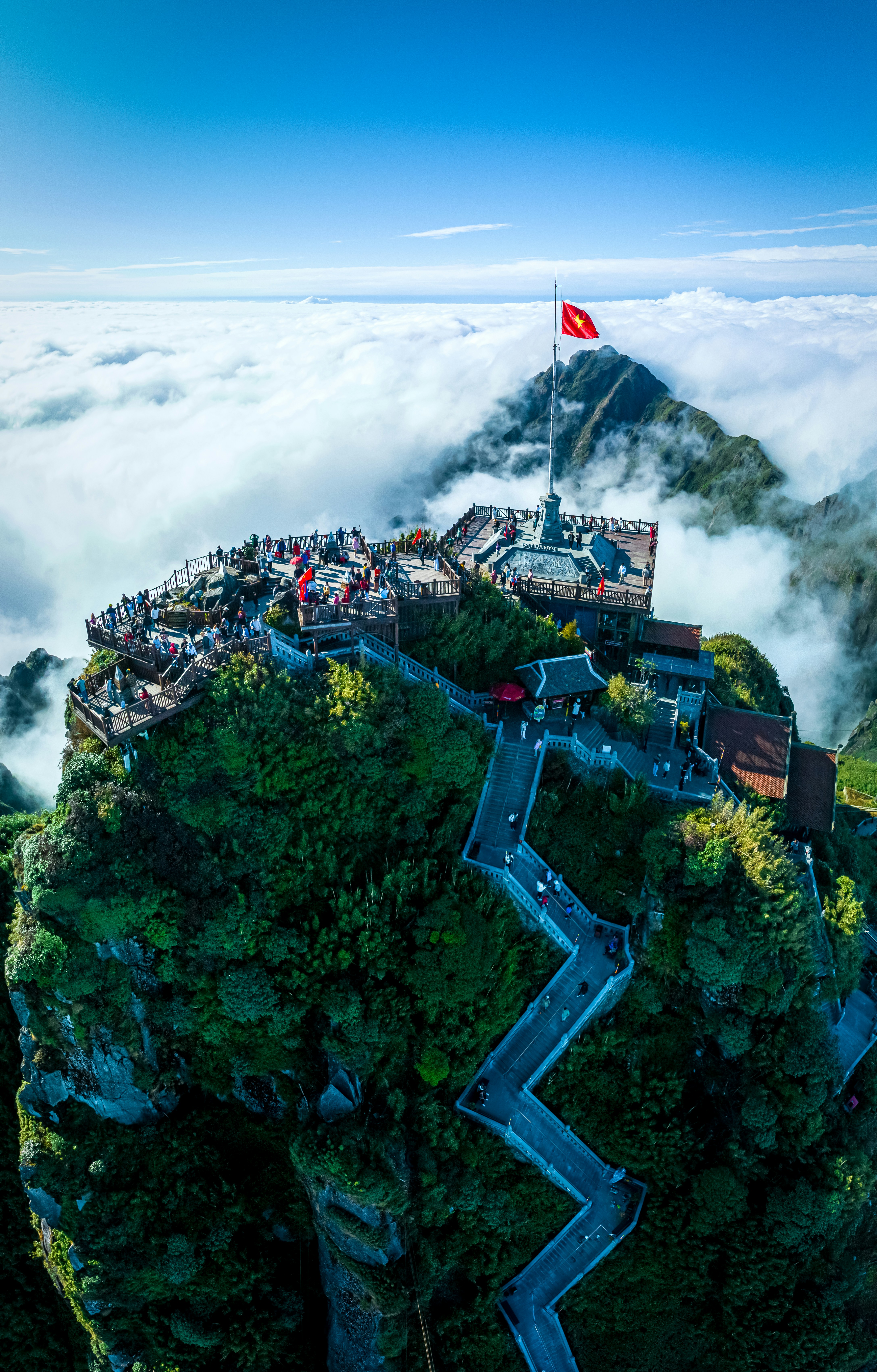 Flag on the Peak: A Step Spiral Above the Clouds