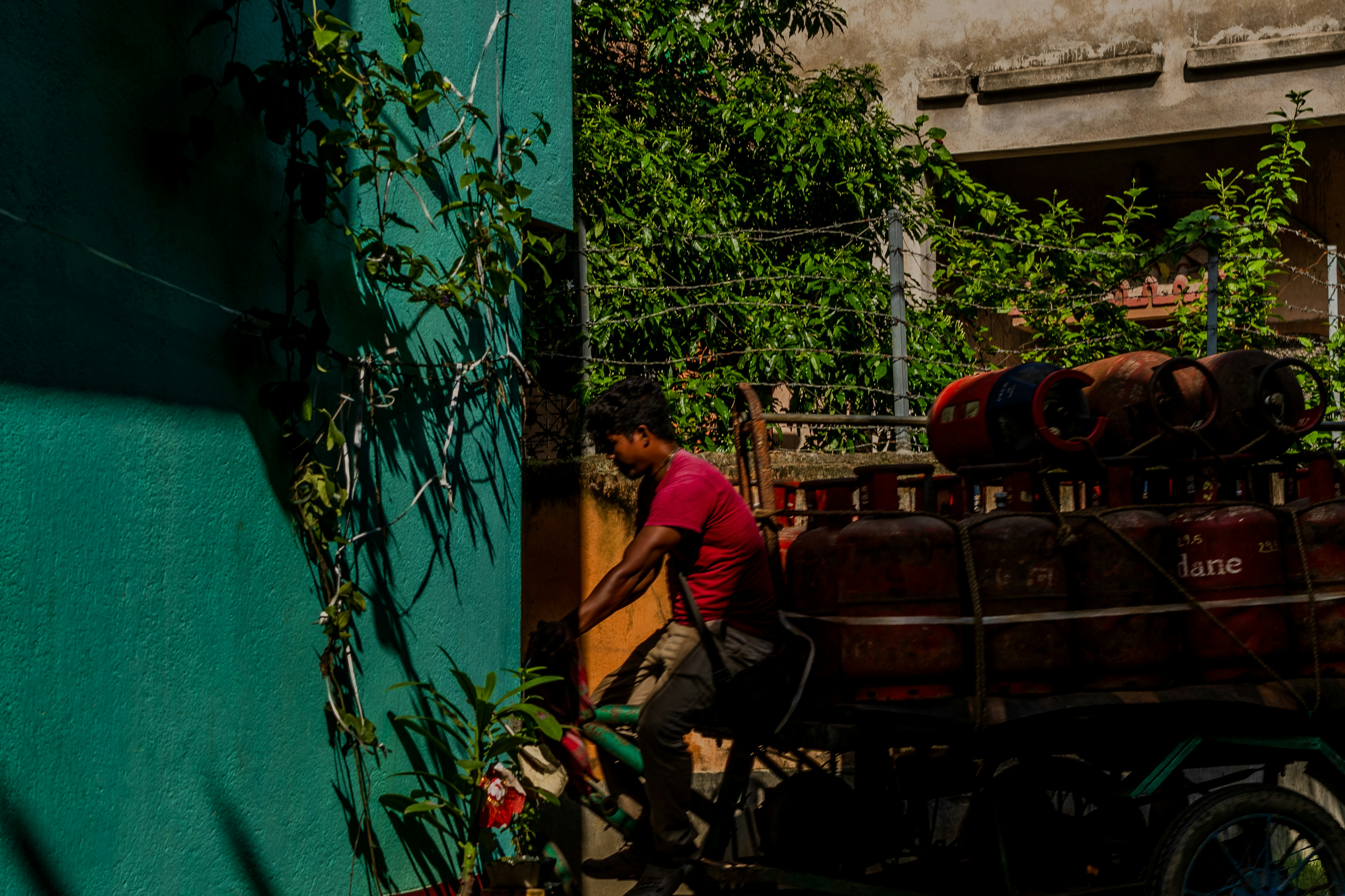 Green Wall, Red Shirt, and a Moving Cart
