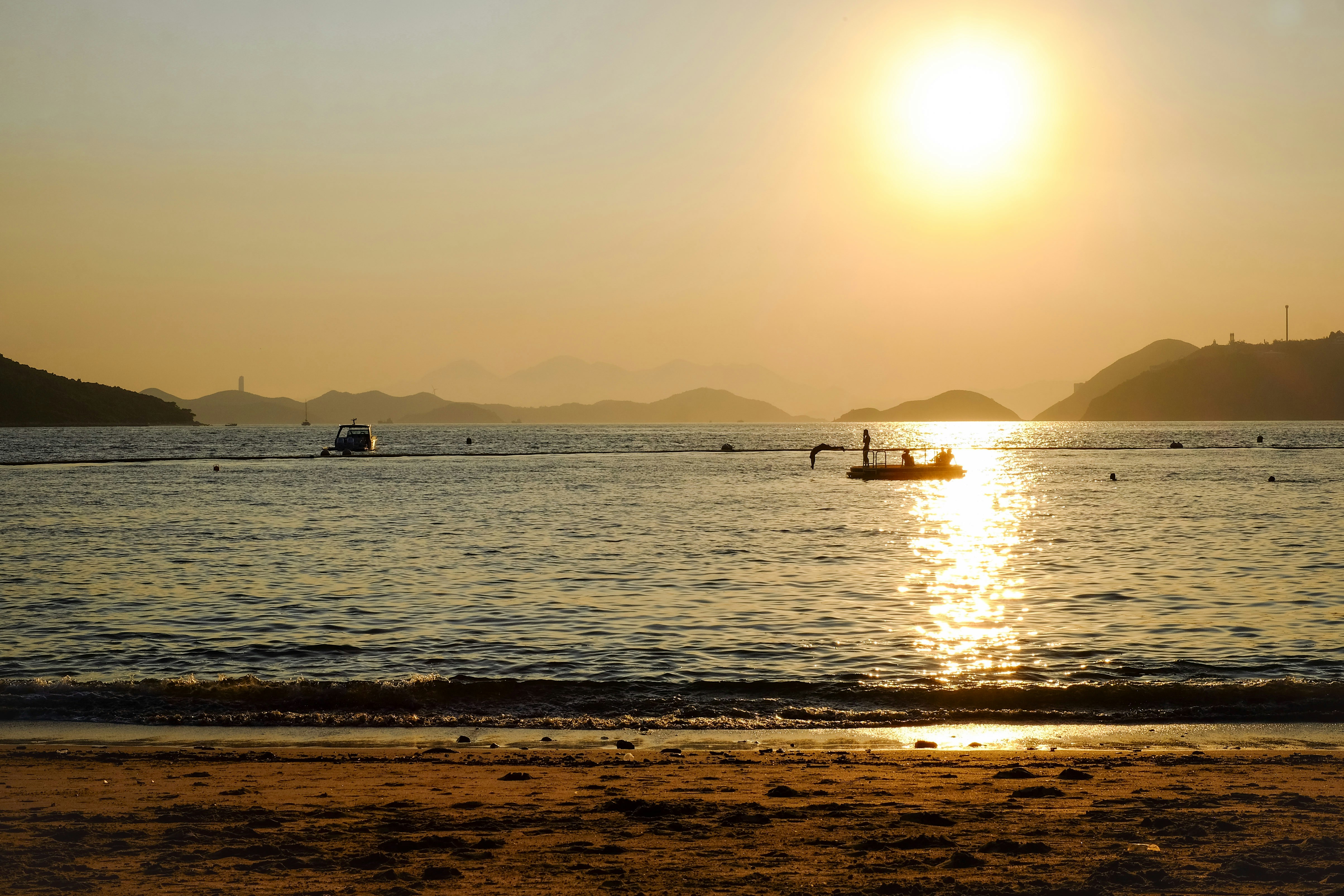 Sunlit Harbor: Boats on a Golden Sea at Dusk