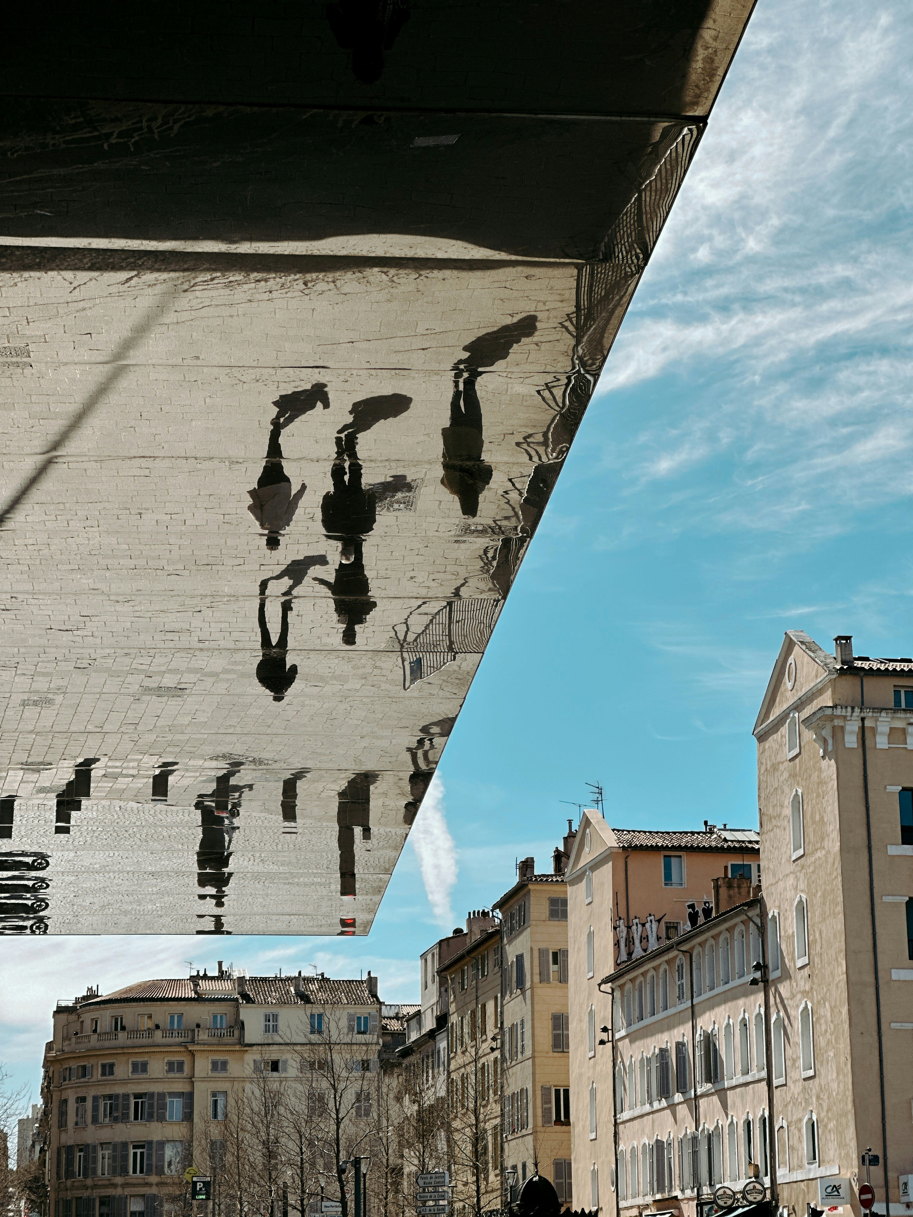 Reflections on the Overhang: A Cityscape Split by Shadow and Sky