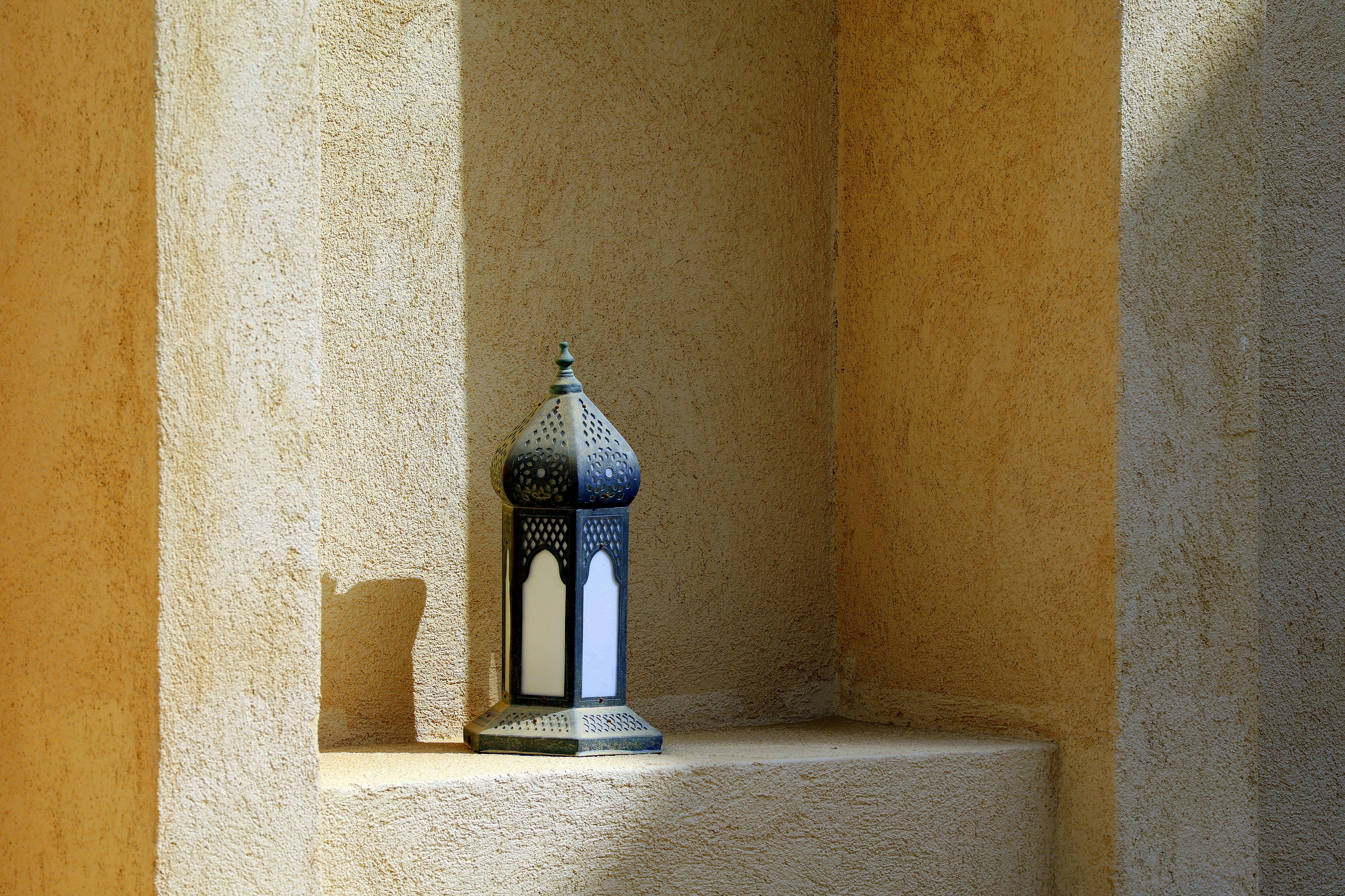 Lantern on Sunlit Terrace: Geometry of Light and Shadow