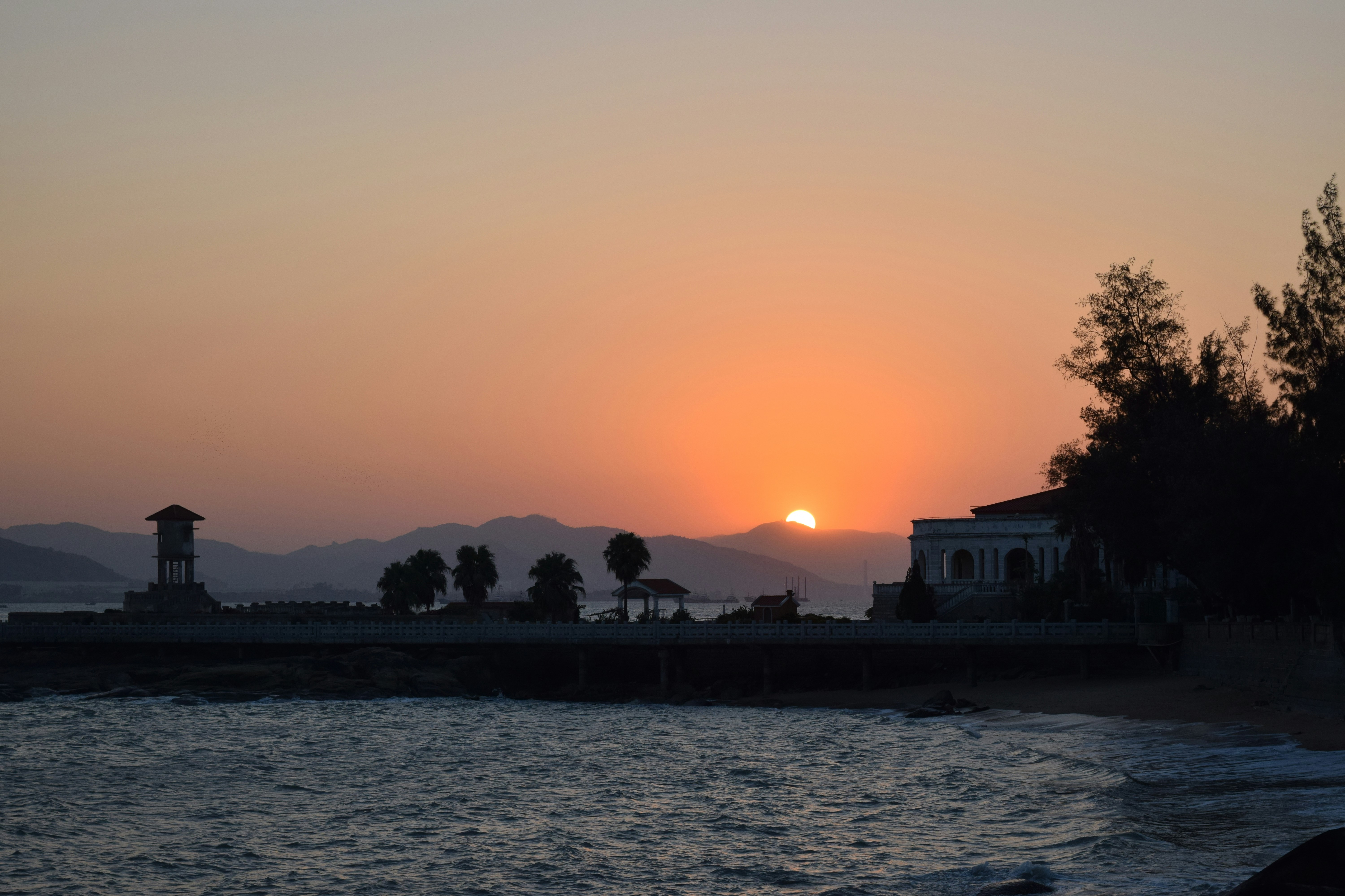 Sunset Silhouette Over a Tranquil Seascape