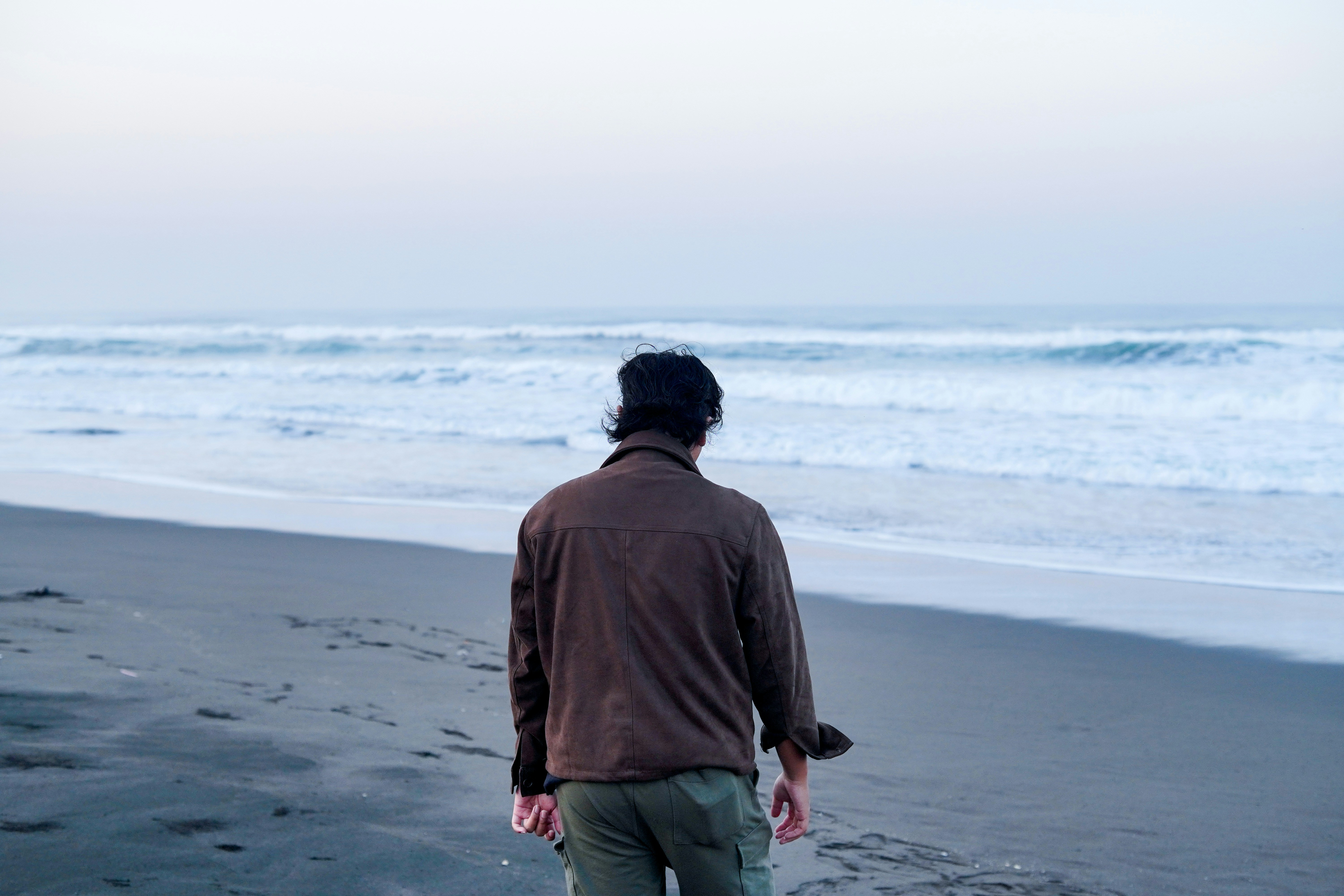 Evening Walk: A Quiet Figure Toward the Sea