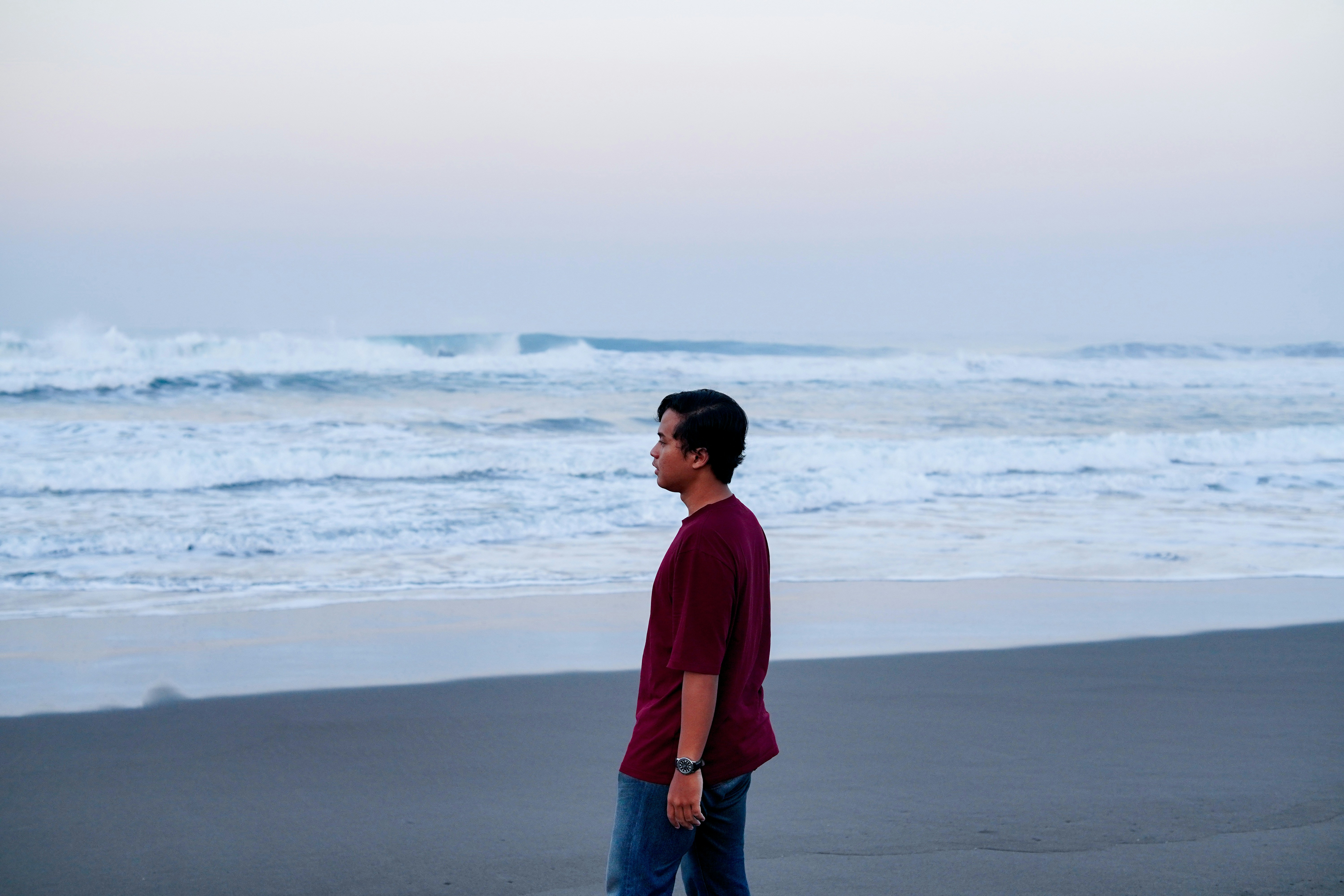 A Quiet Shoreline Portrait: The Man in Profile Against Gentle Waves