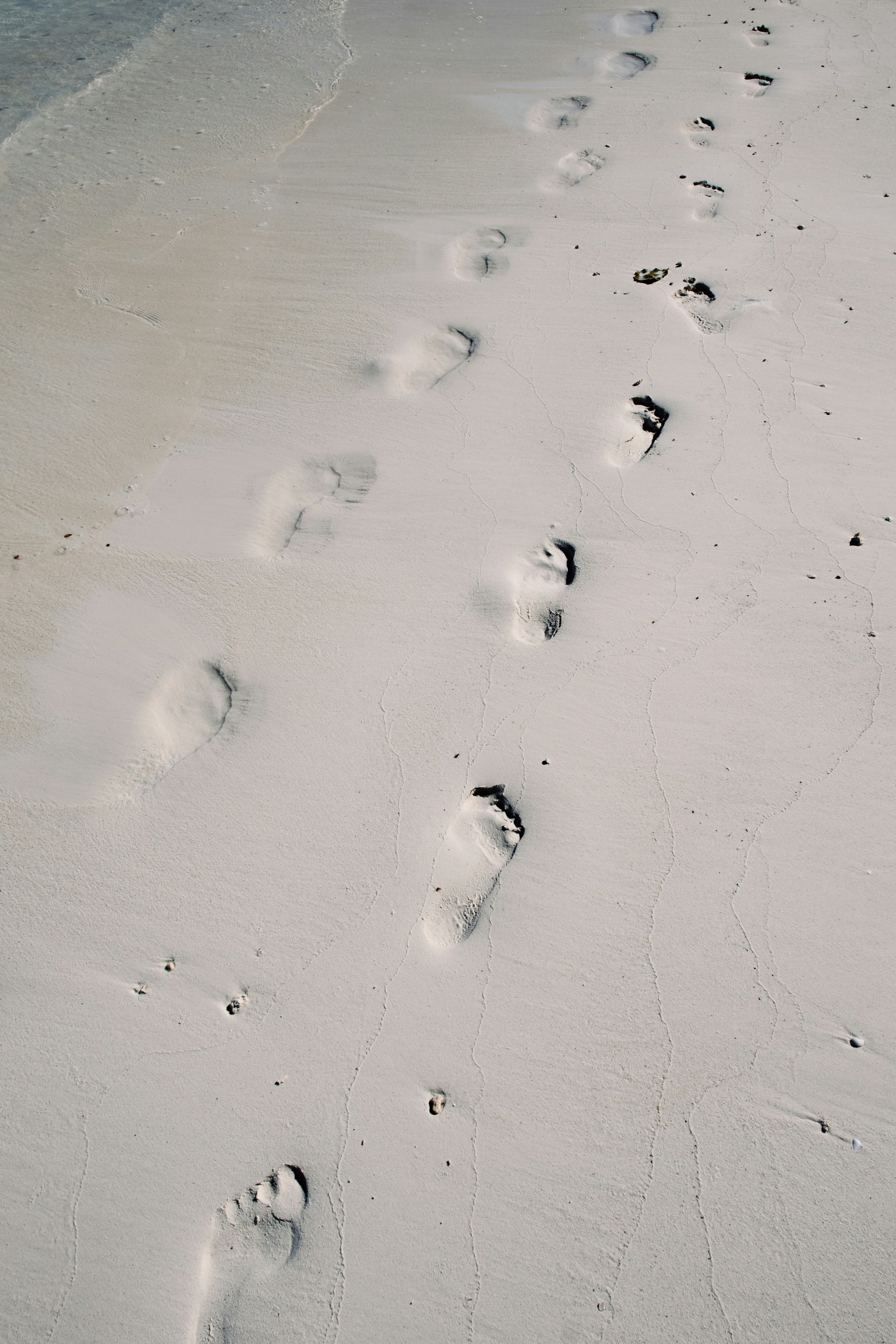 Footprints in Quiet Beach Snow-White Sand