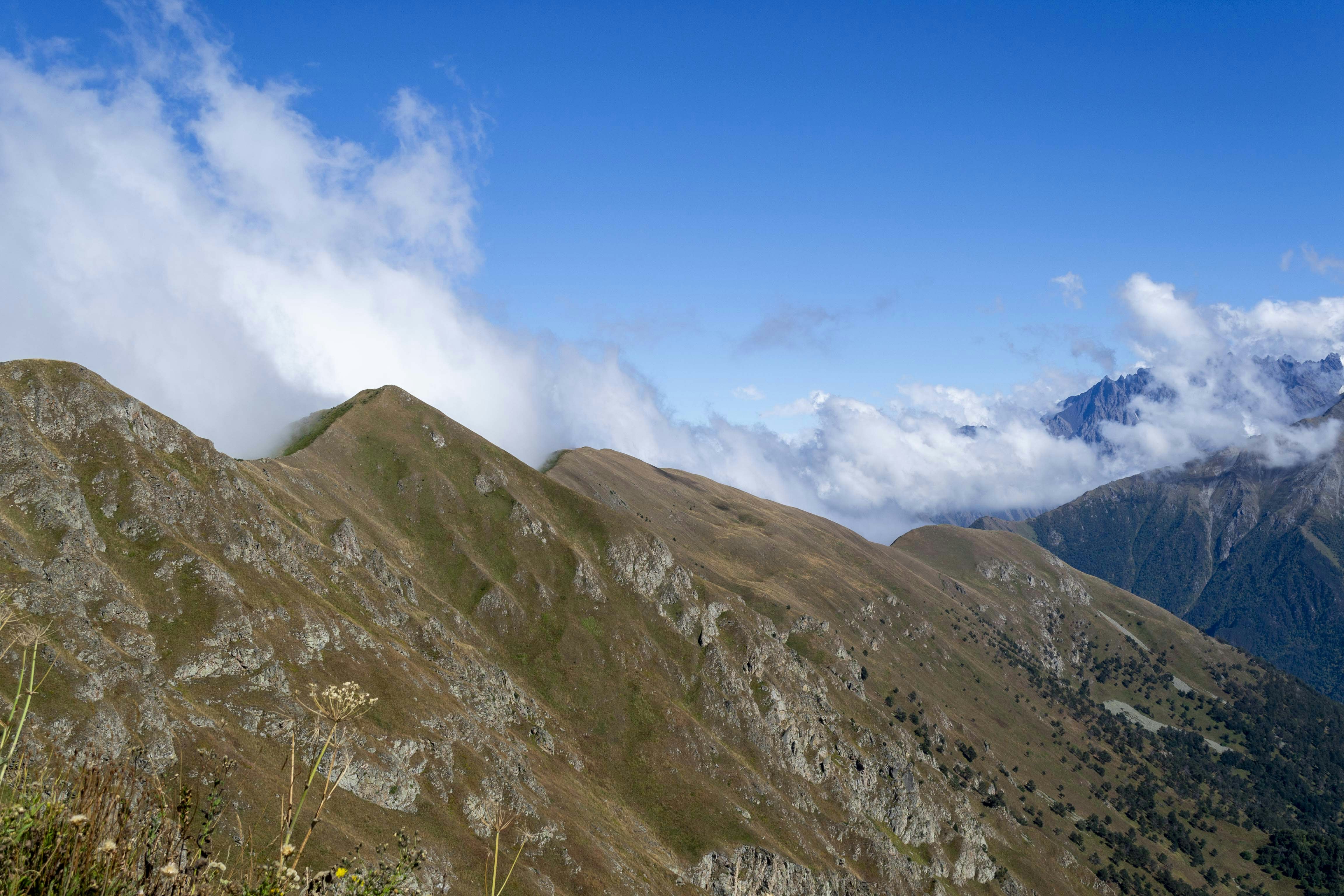 Cloud-kissed Ridge Beneath a Clear Alpine Sky