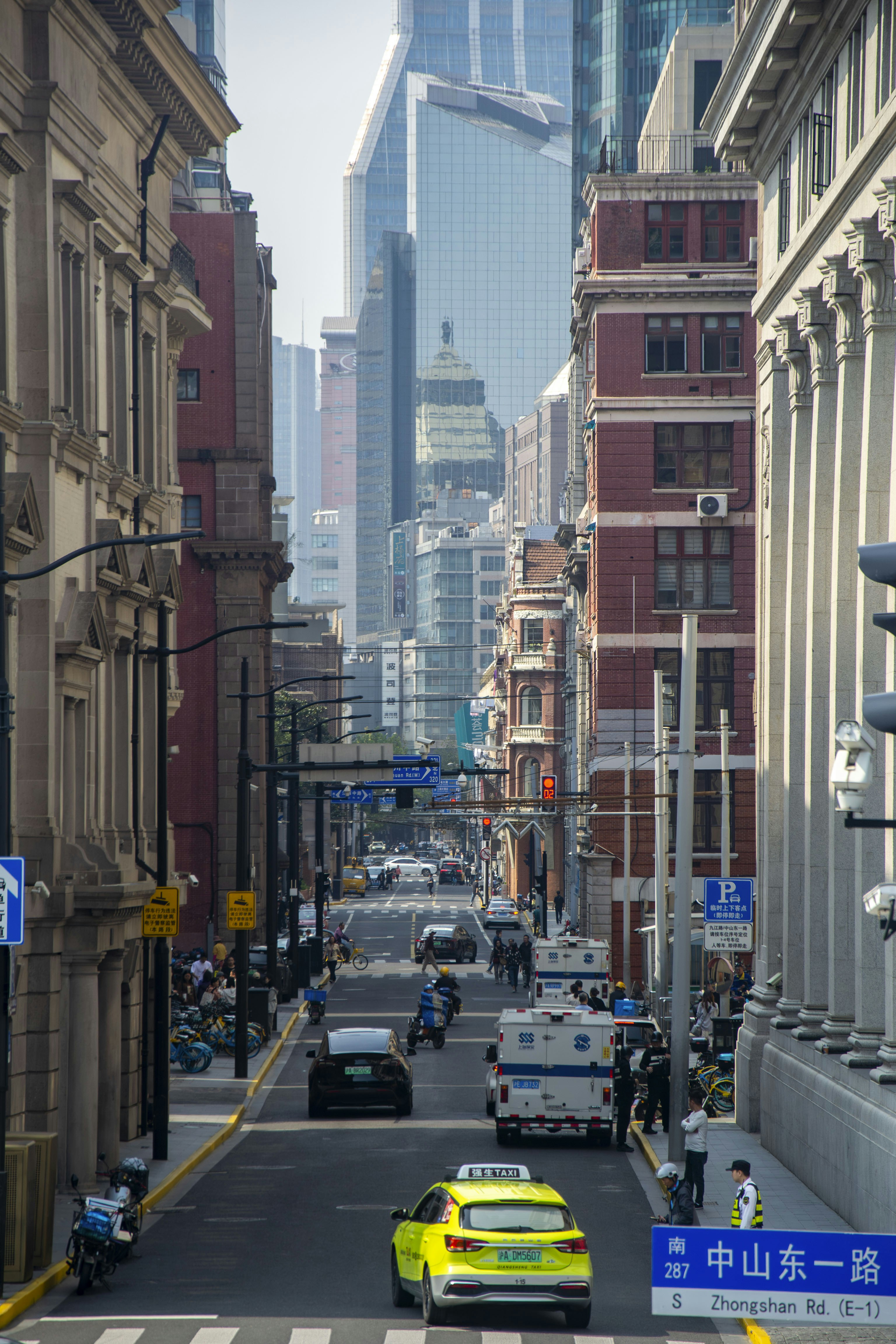 Urban Corridor: A Street Hatch of Tall Buildings and a Bright Taxi