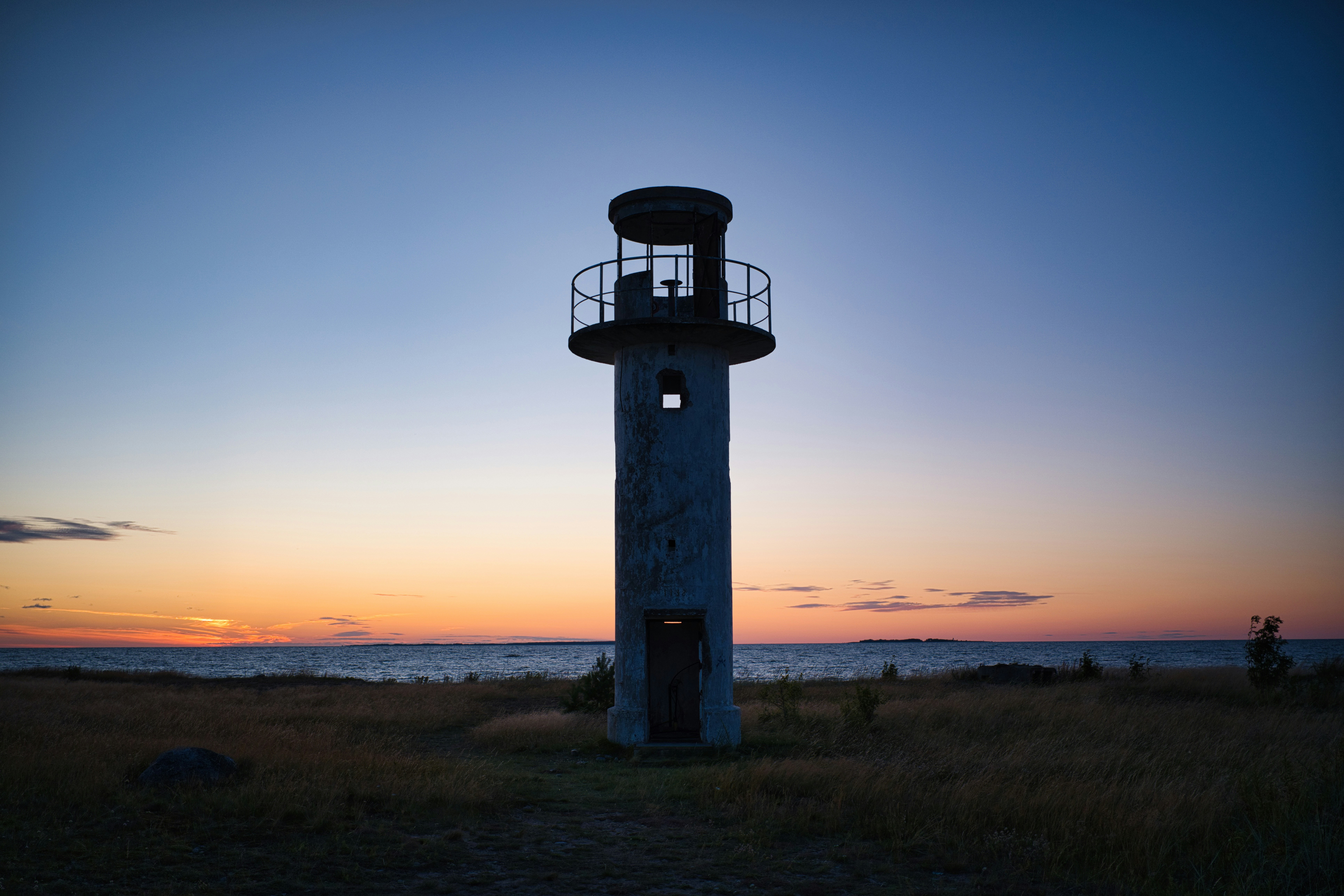 Solitary Beacon at Dusk: A Lighthouse Standing Against the Horizon