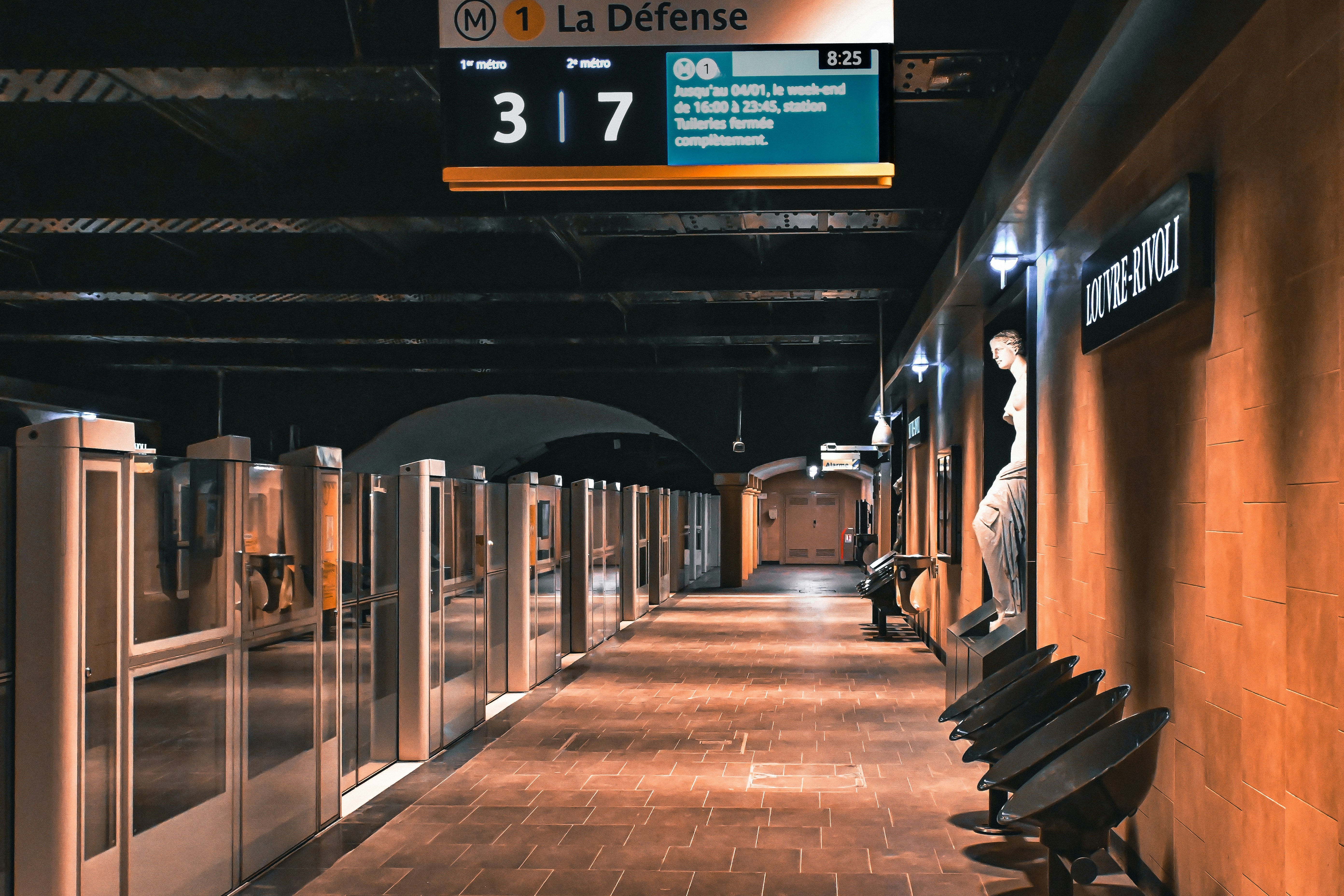 Quiet Platform at La Défense: Neon Signage and Empty Benches