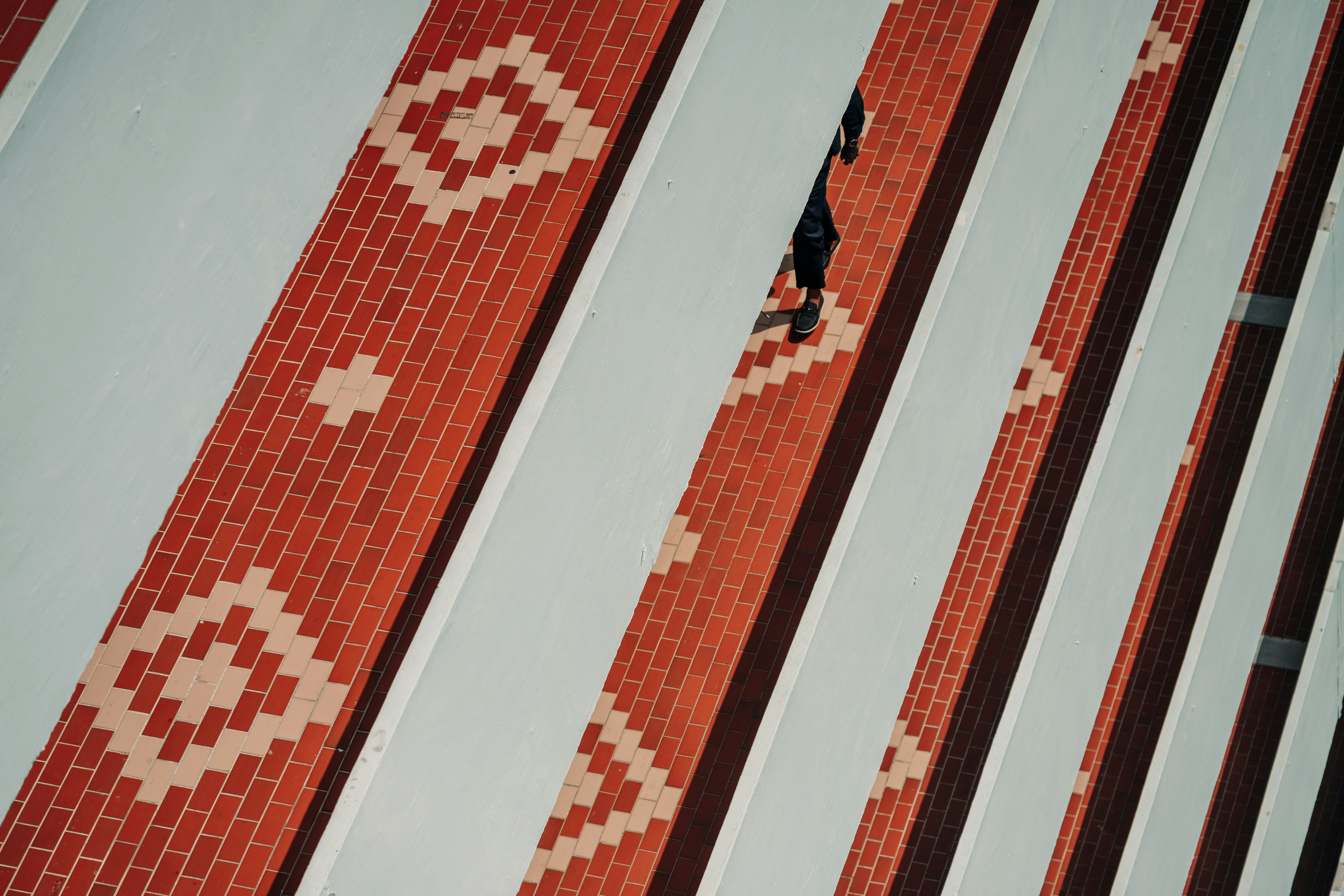 Geometric Steps: Mosaic Ramps with Distant Figure in a Tilted Corridor