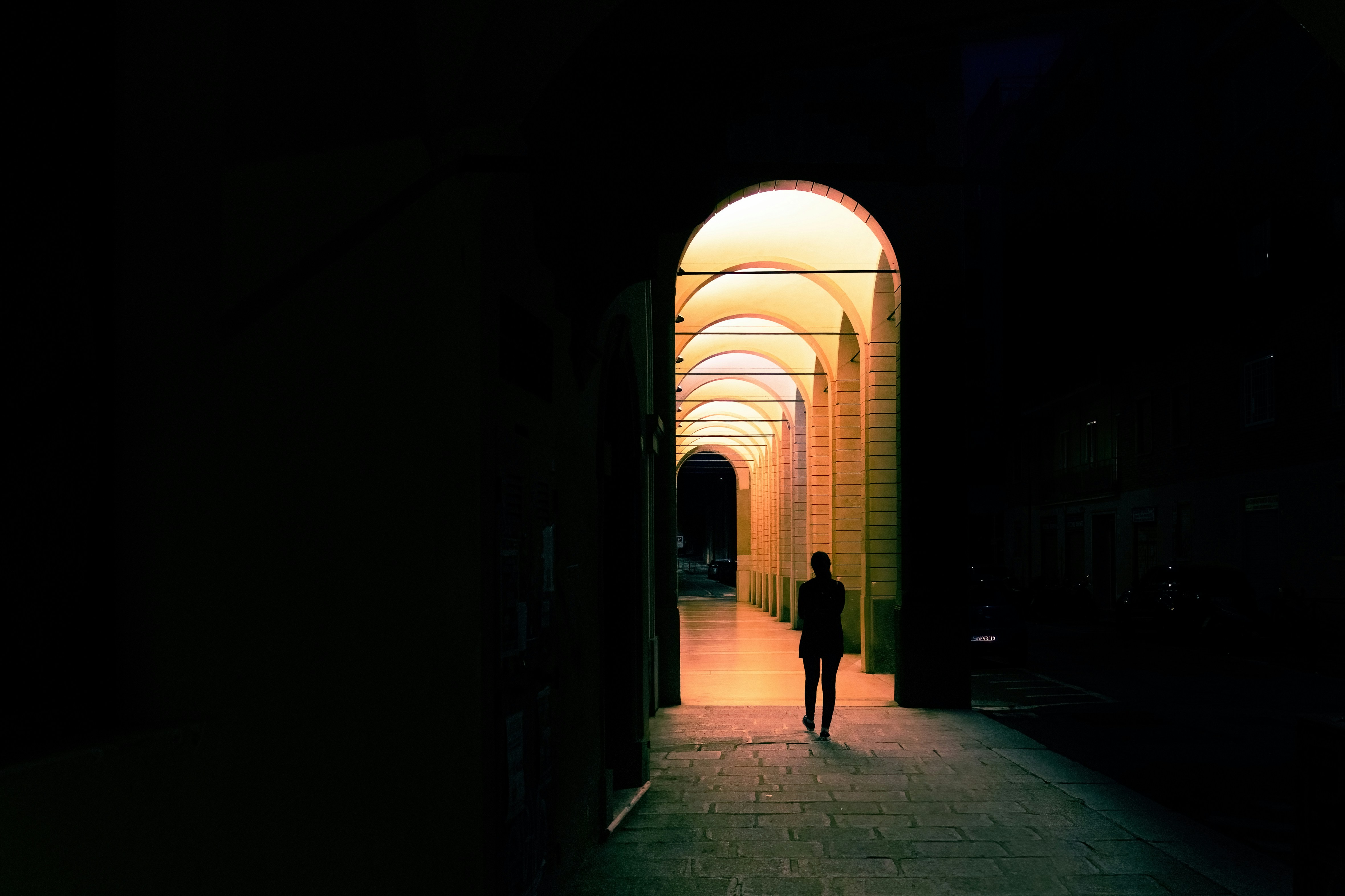 Archway Corridor: A Luminous Walkway into Night