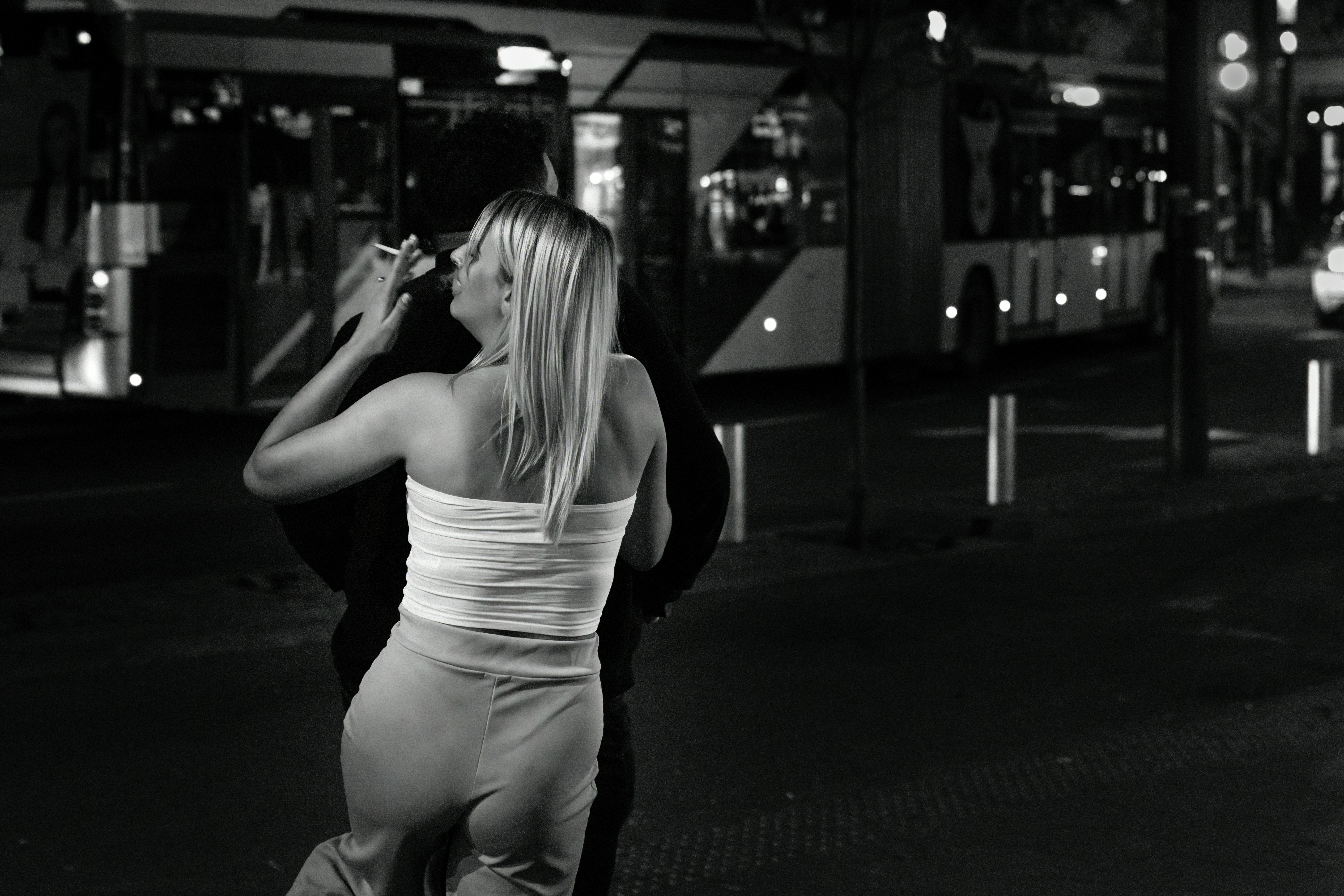 Midnight Encounter: A Silhouette of Connection in Neon Street Light
