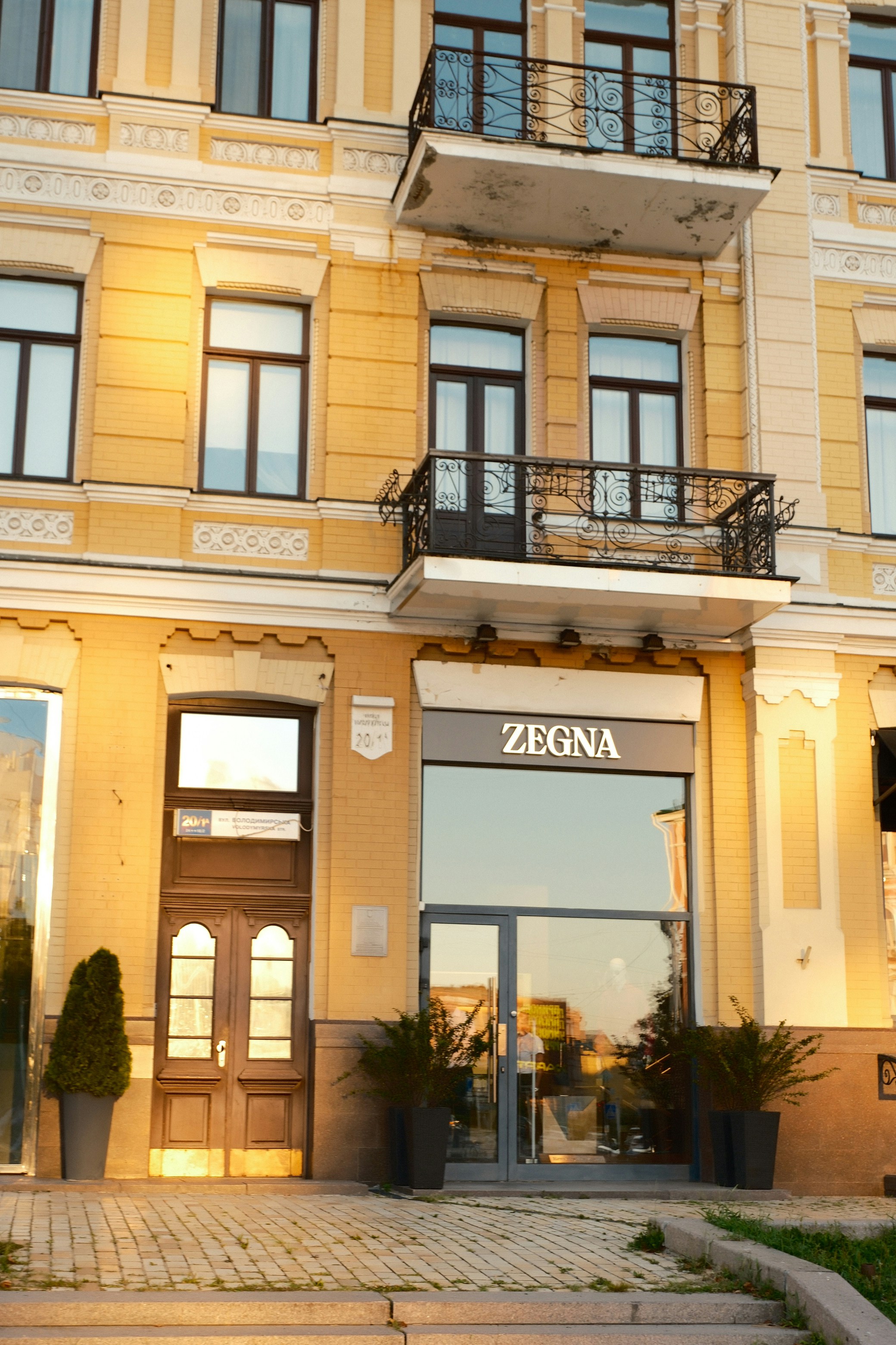 Yellow Brick Facade with ZEGNA Store and Balcony Details