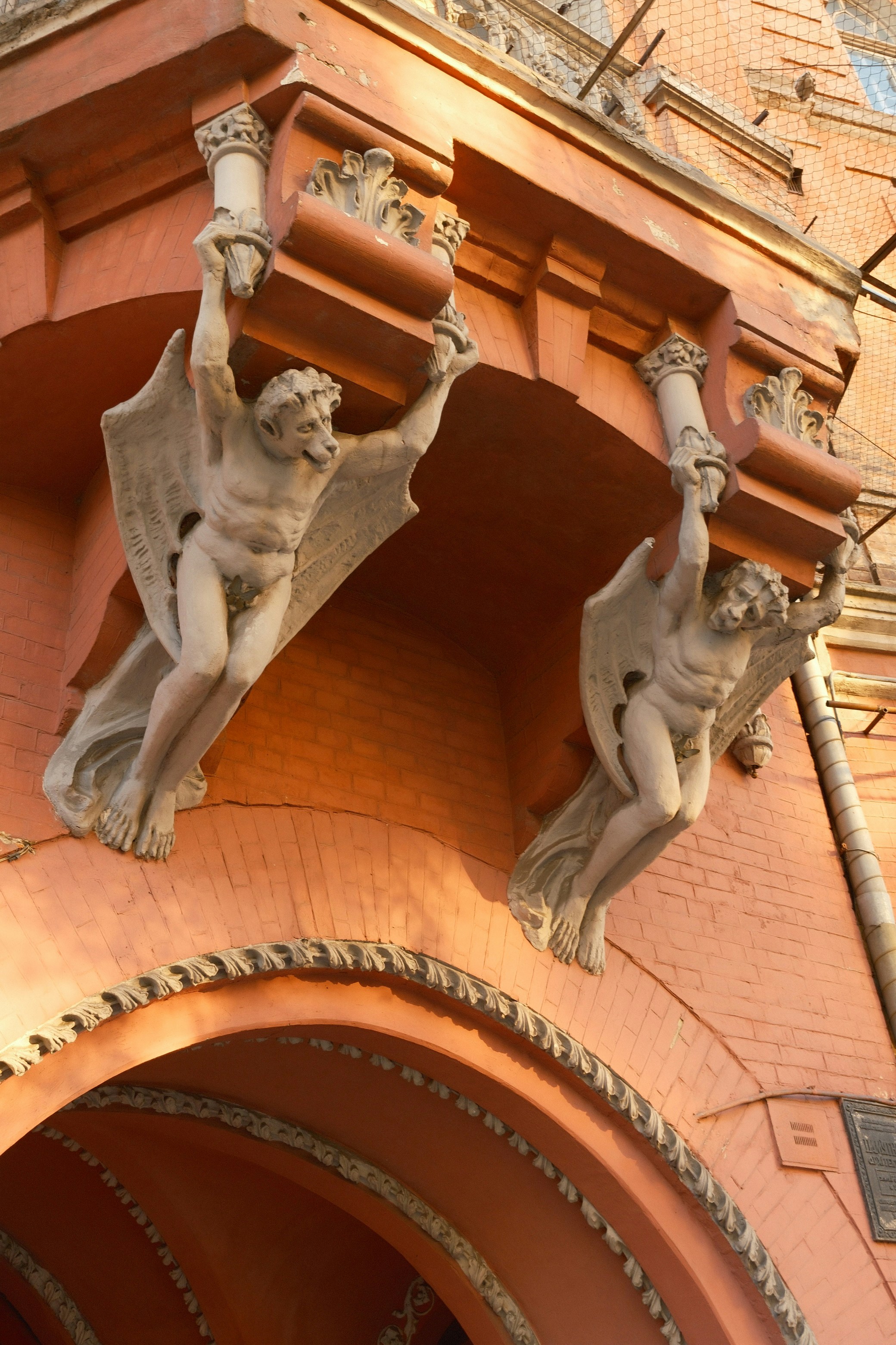 Winged guardians Over Red Brick Architecture