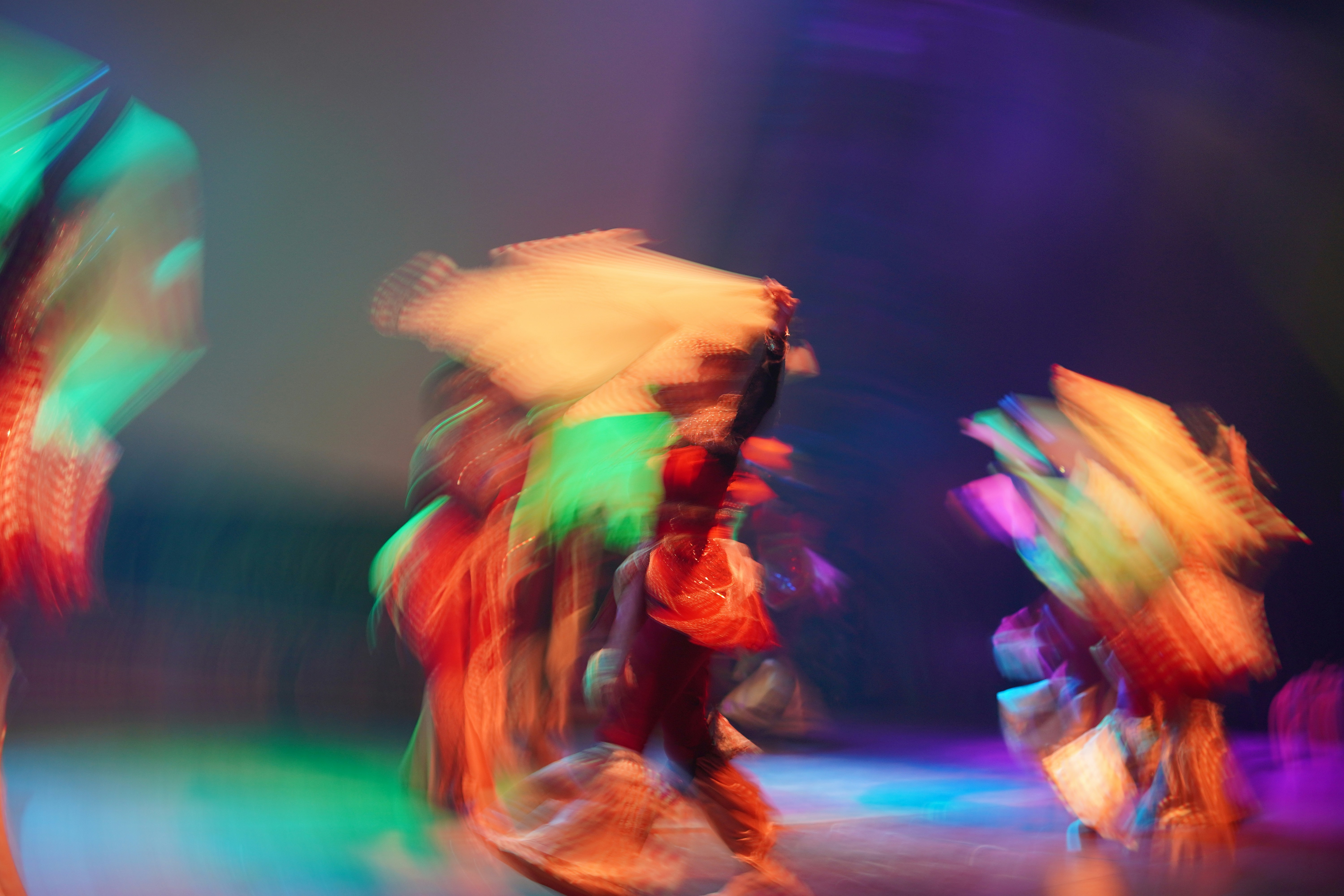 Blurred Motion on Stage: Colors Swirl in a Night Performance