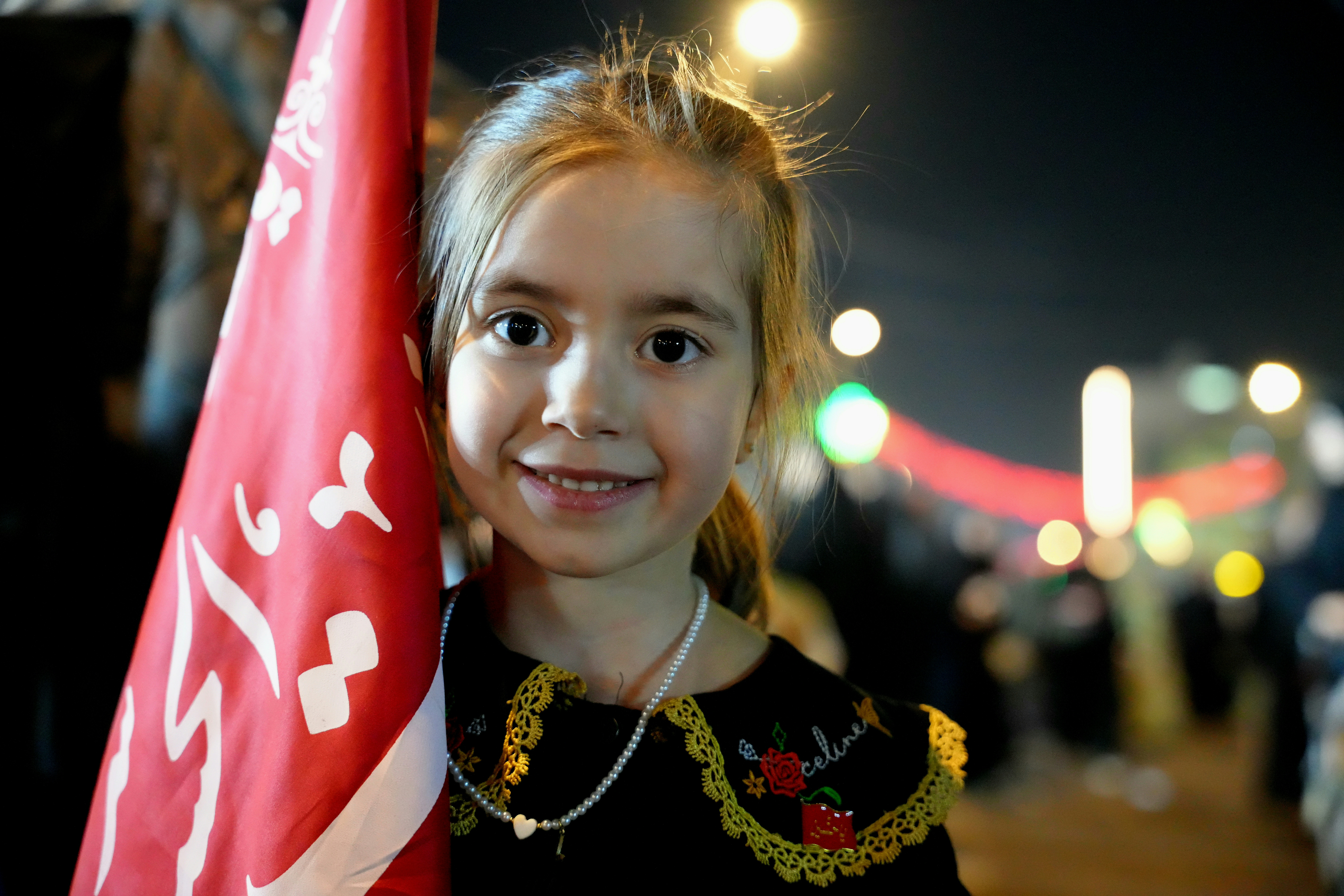 Bright-eyed Moment: A Girl and the Red Banner at Night