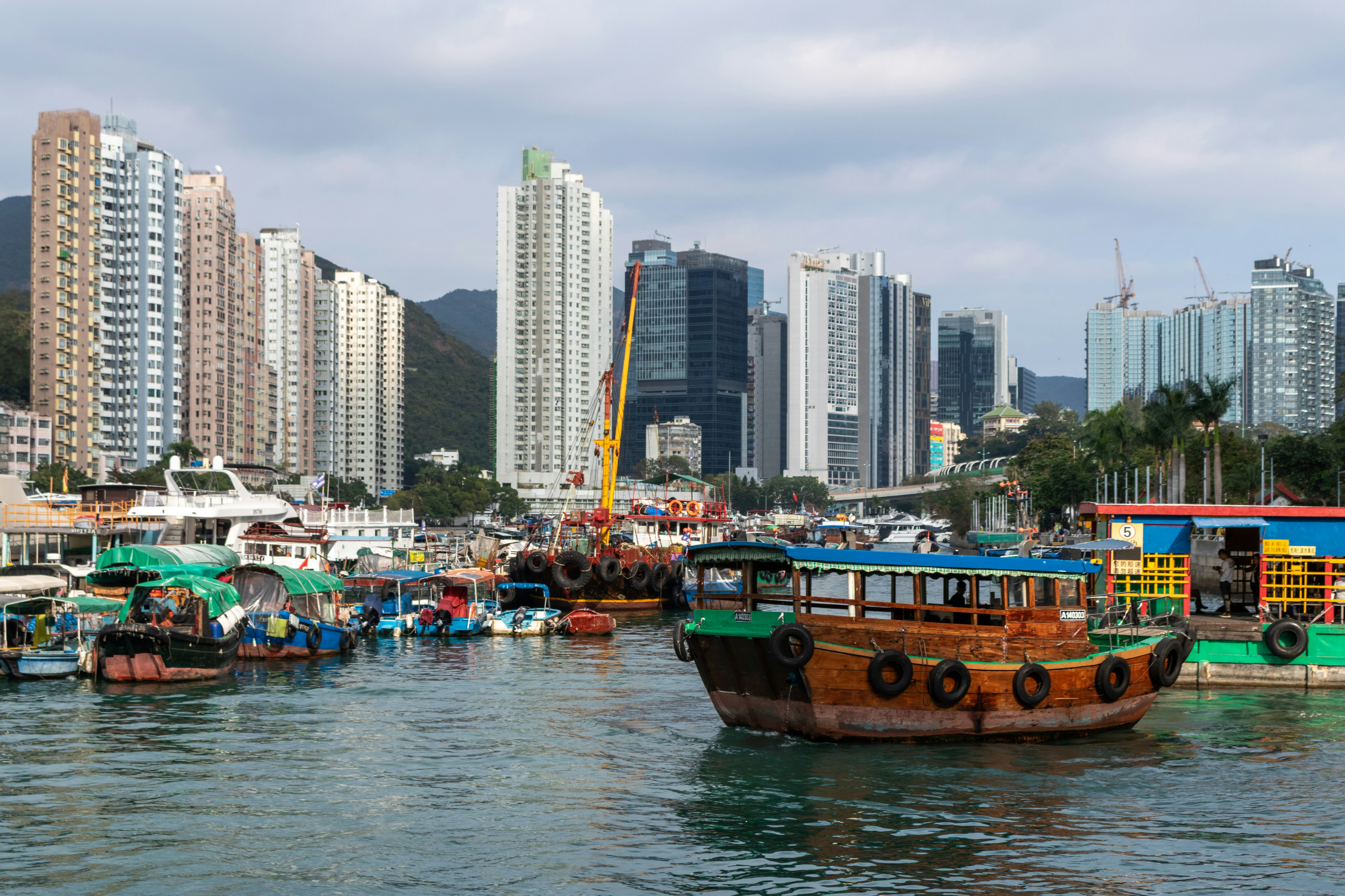 Harbor Bustle: City Skyscrapers Rise Behind a Fleet of Wooden Boats
