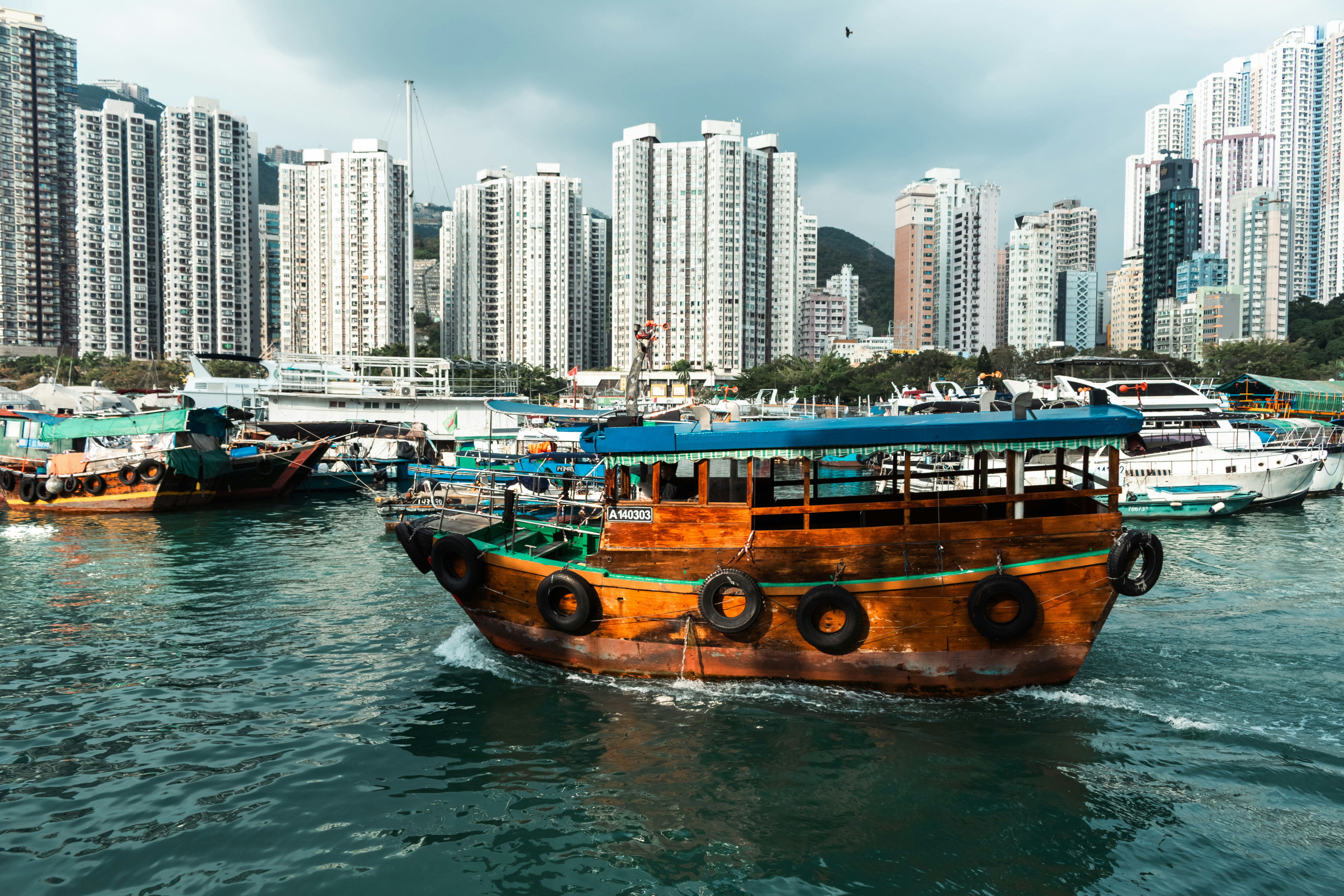 Orange boat at the harbor storm of glass towers
