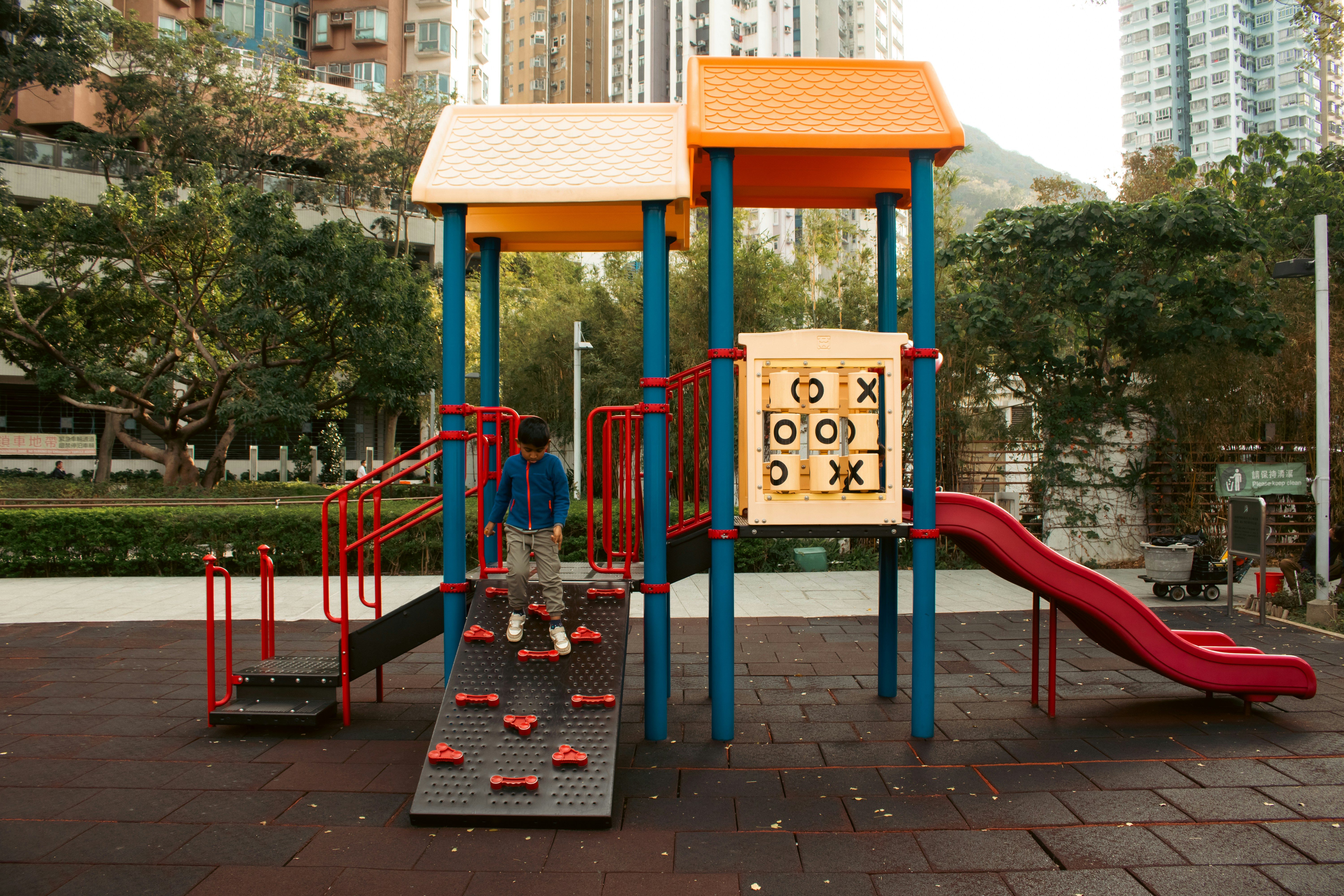 Little climber at the orange-roofed playground towers