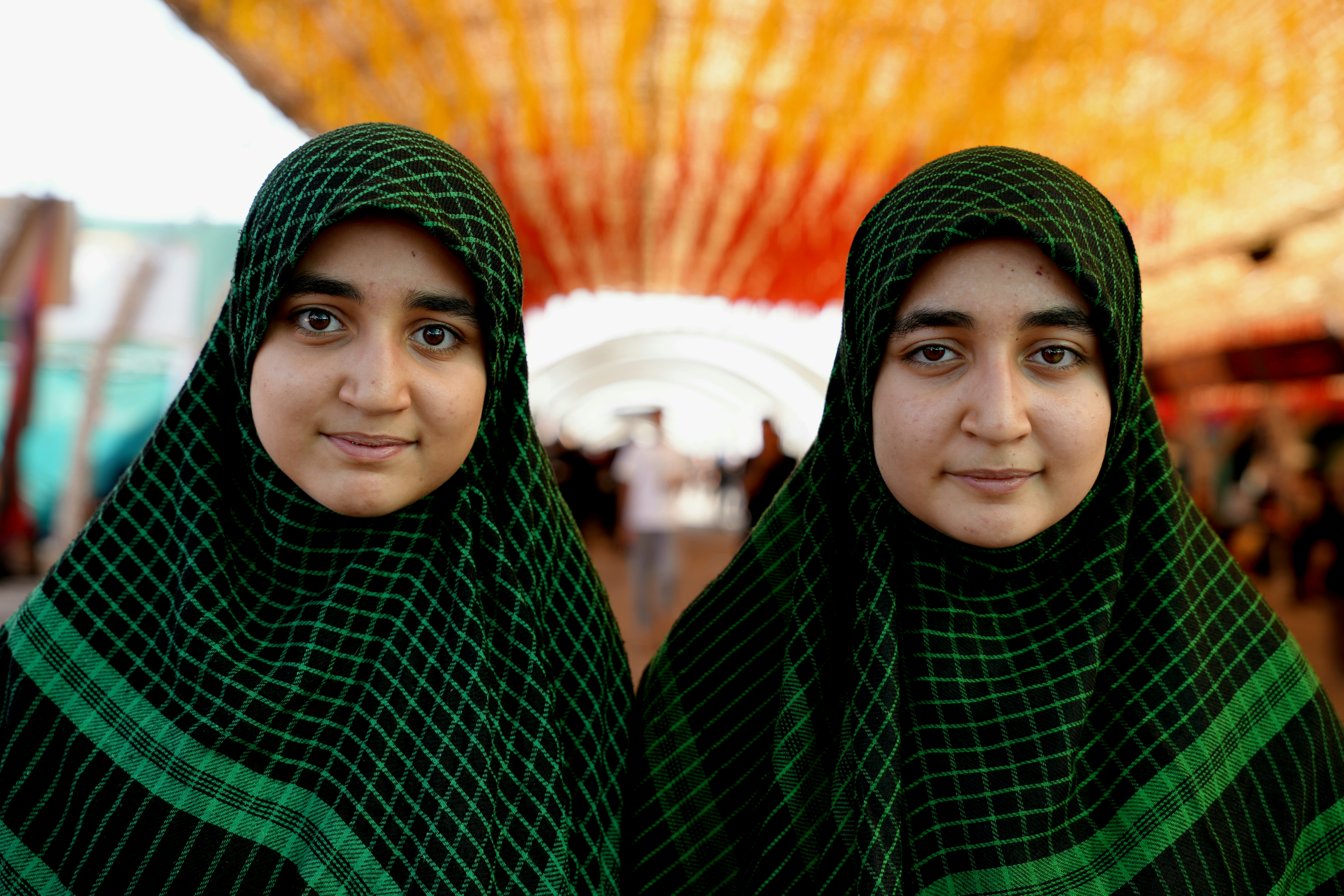 Twin Gazes under a Warm Market Canopy