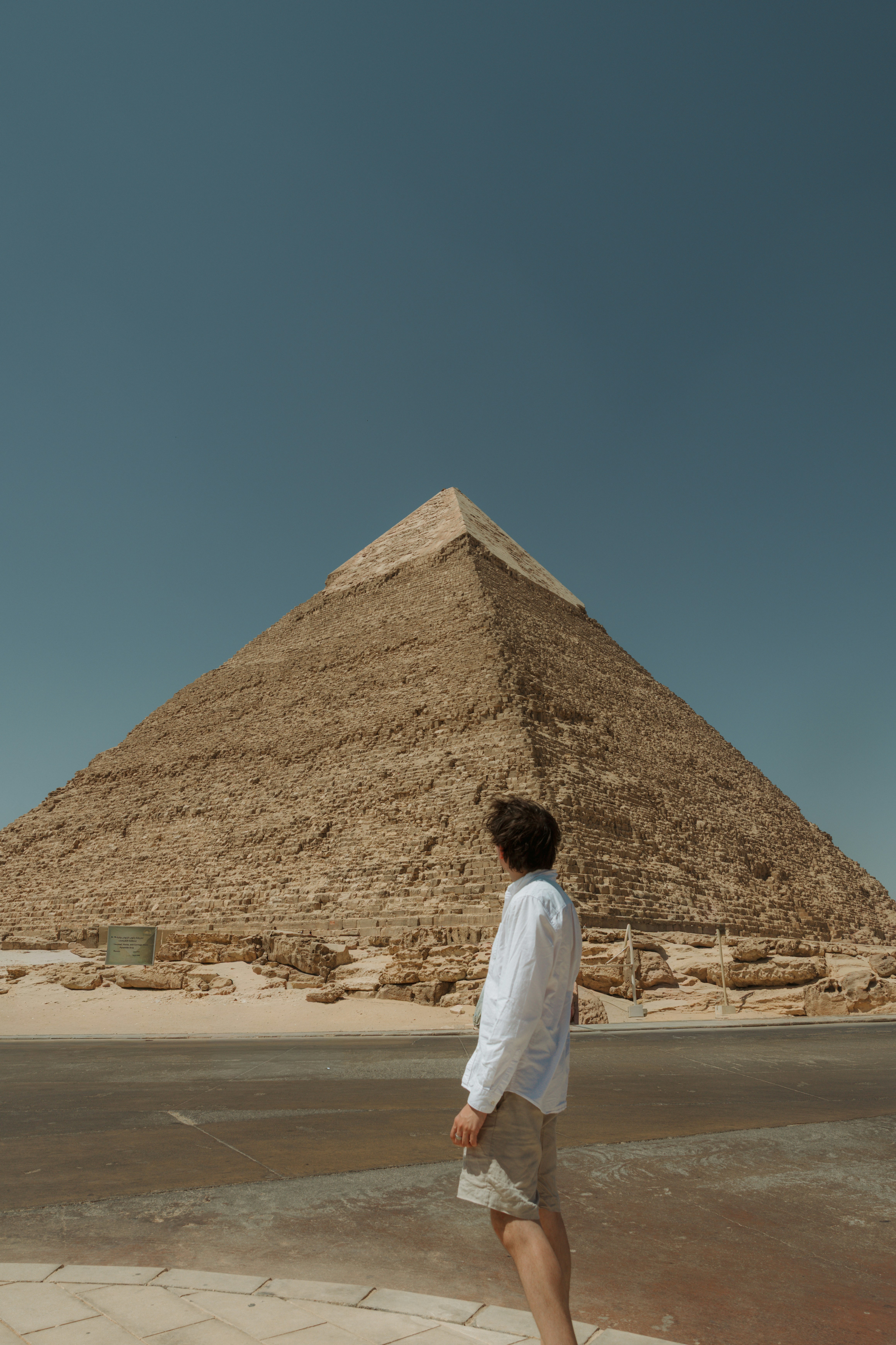 Traveler in White Shirt Before an Ancient Pyramid