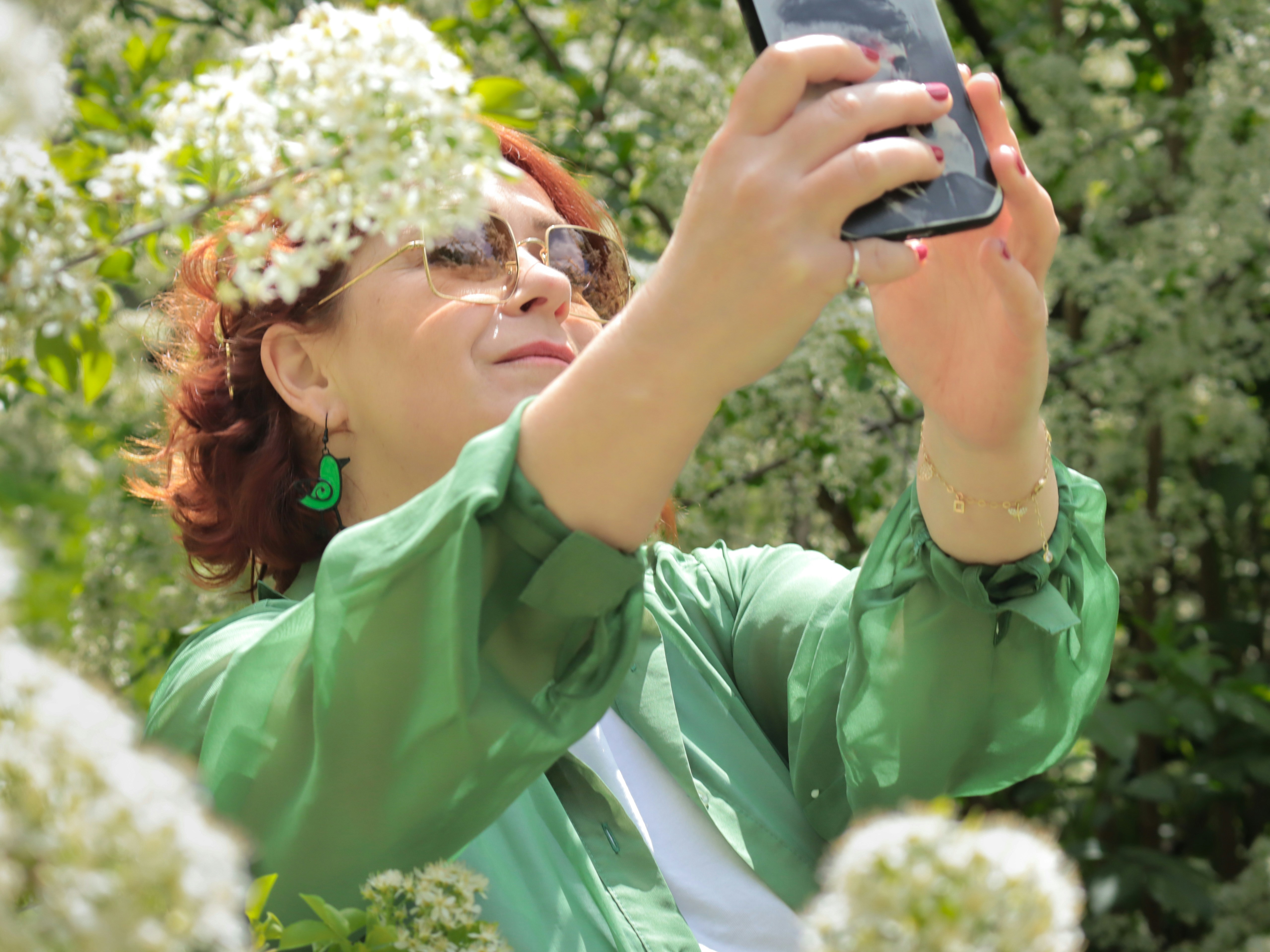 Selfie in Bloom: A Woman Captures a Sunny Moment