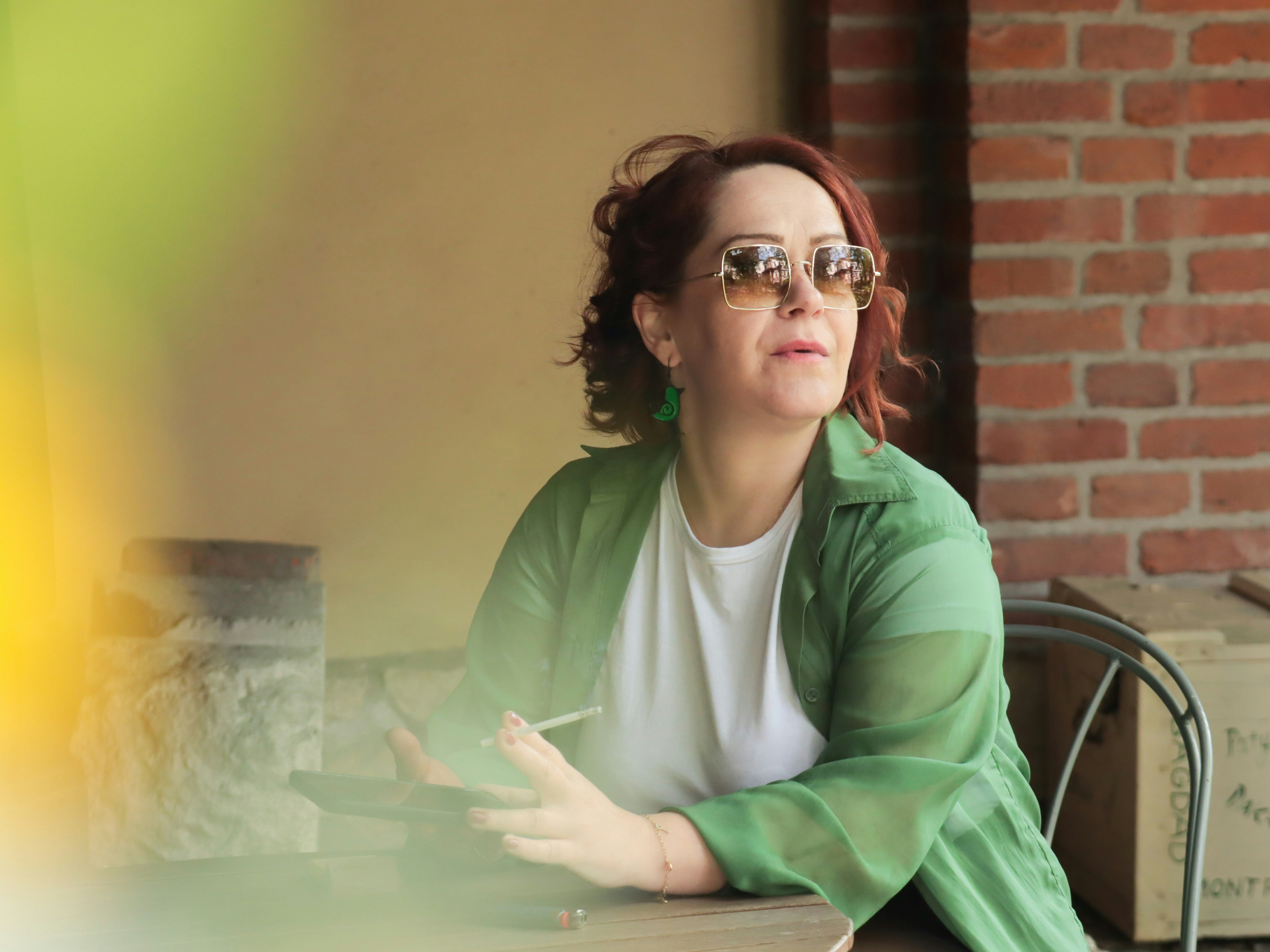 Amber Glasses, Green Coat: A Moment of Casual Confidence