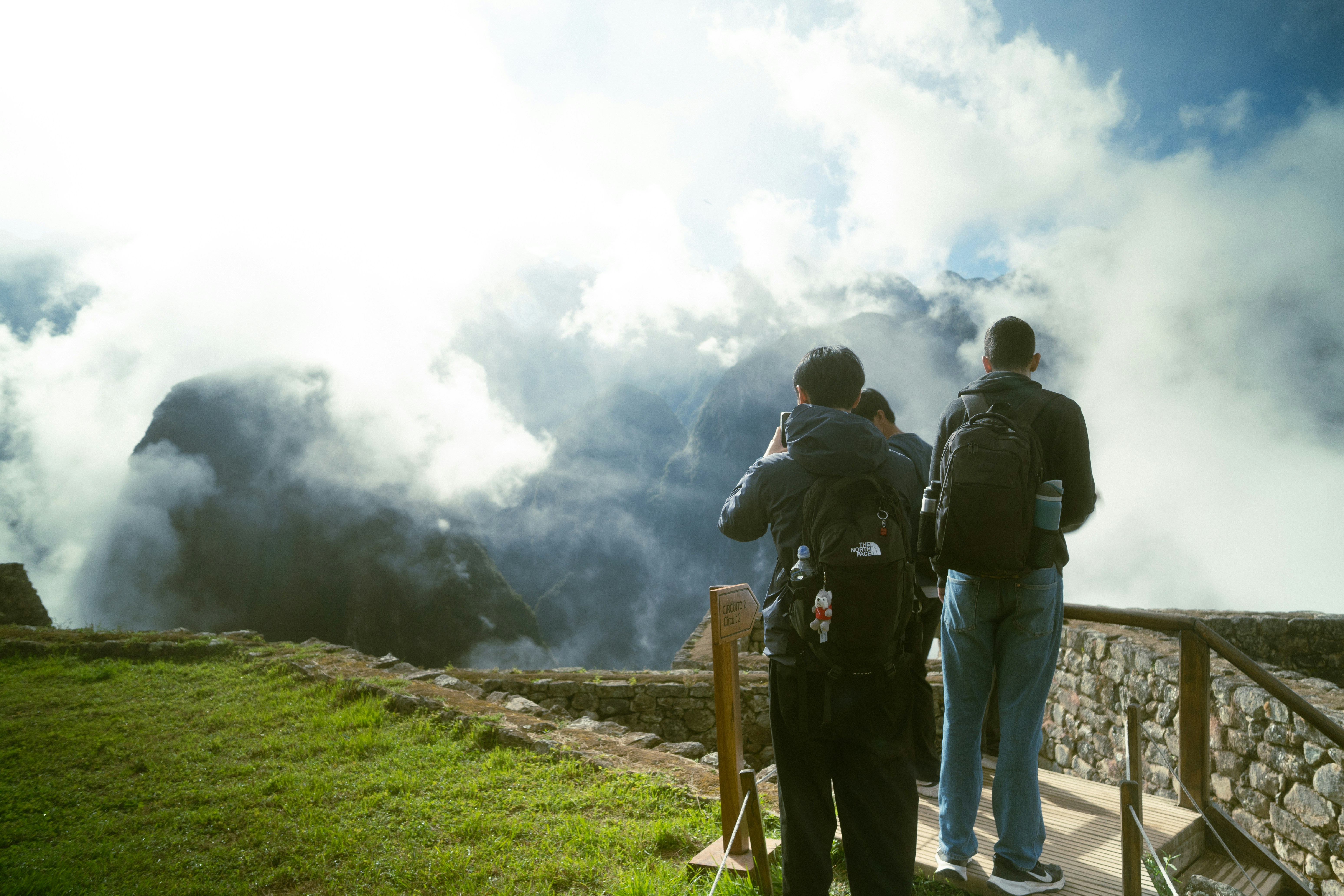 Stewards of the Mist: Two hikers at a cliffside lookout