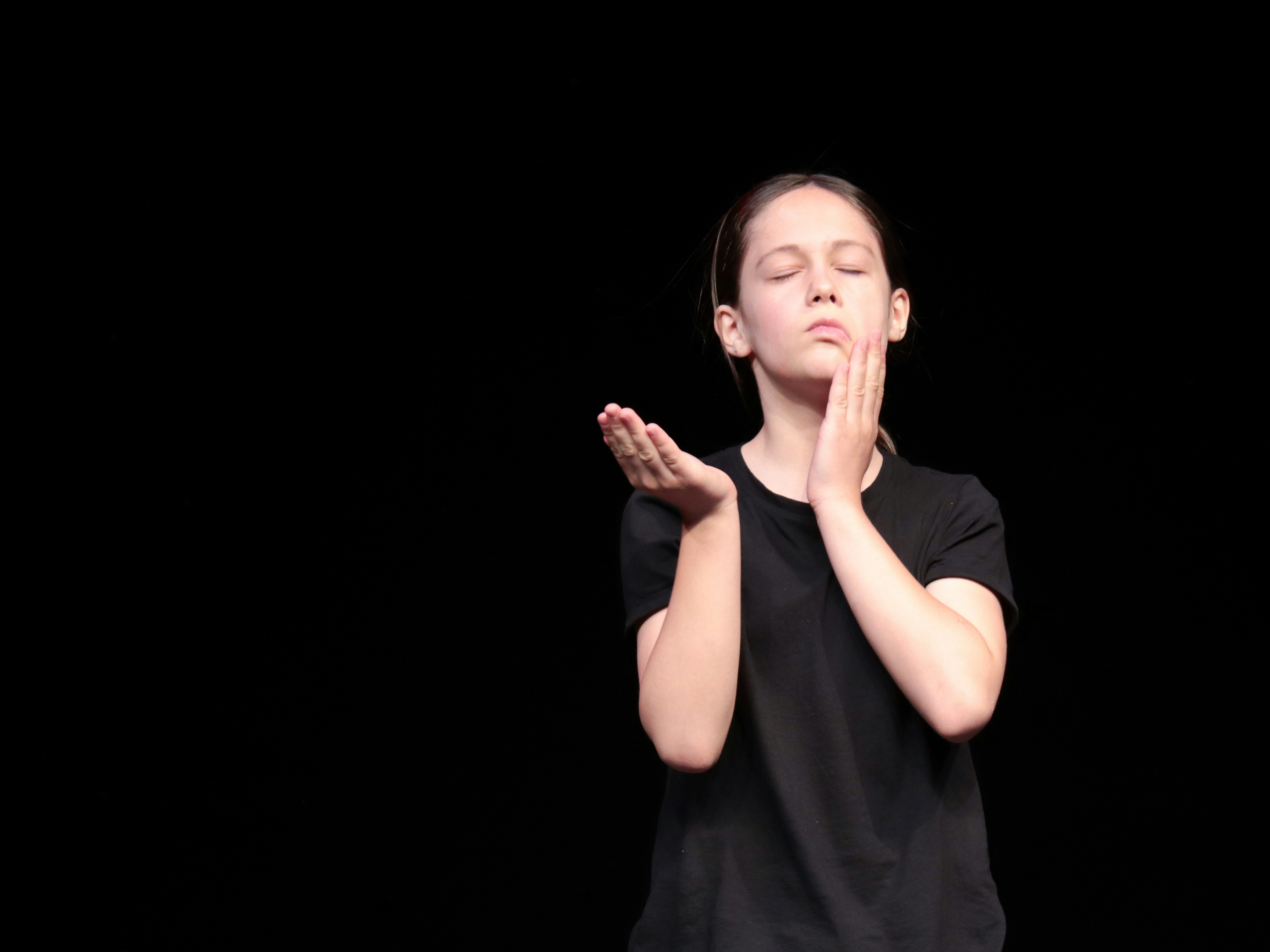 Silent Gesture: Portrait of Calm in a Black Studio