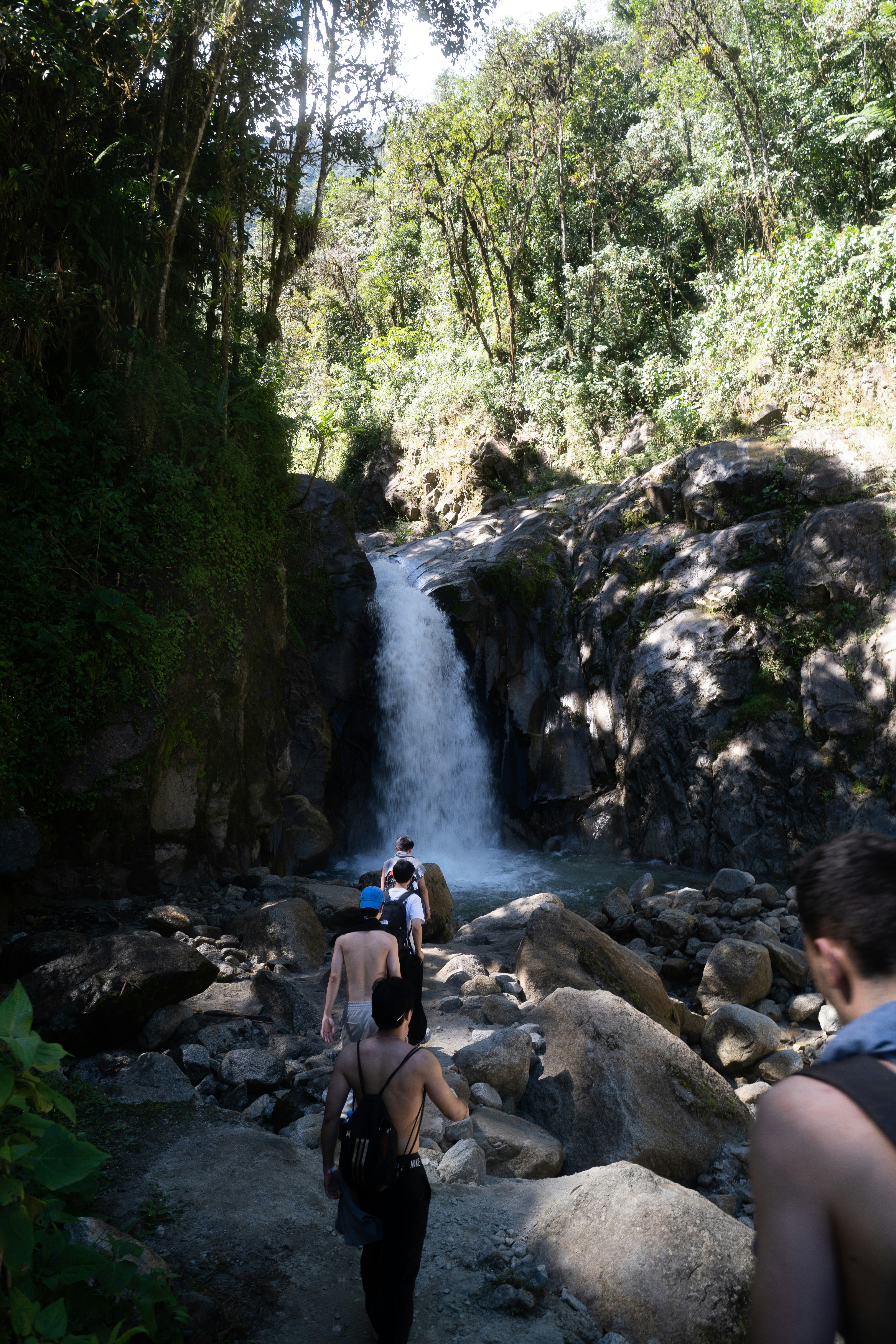 Cascade Ascent: Hikers Trek Toward a Hidden Falls