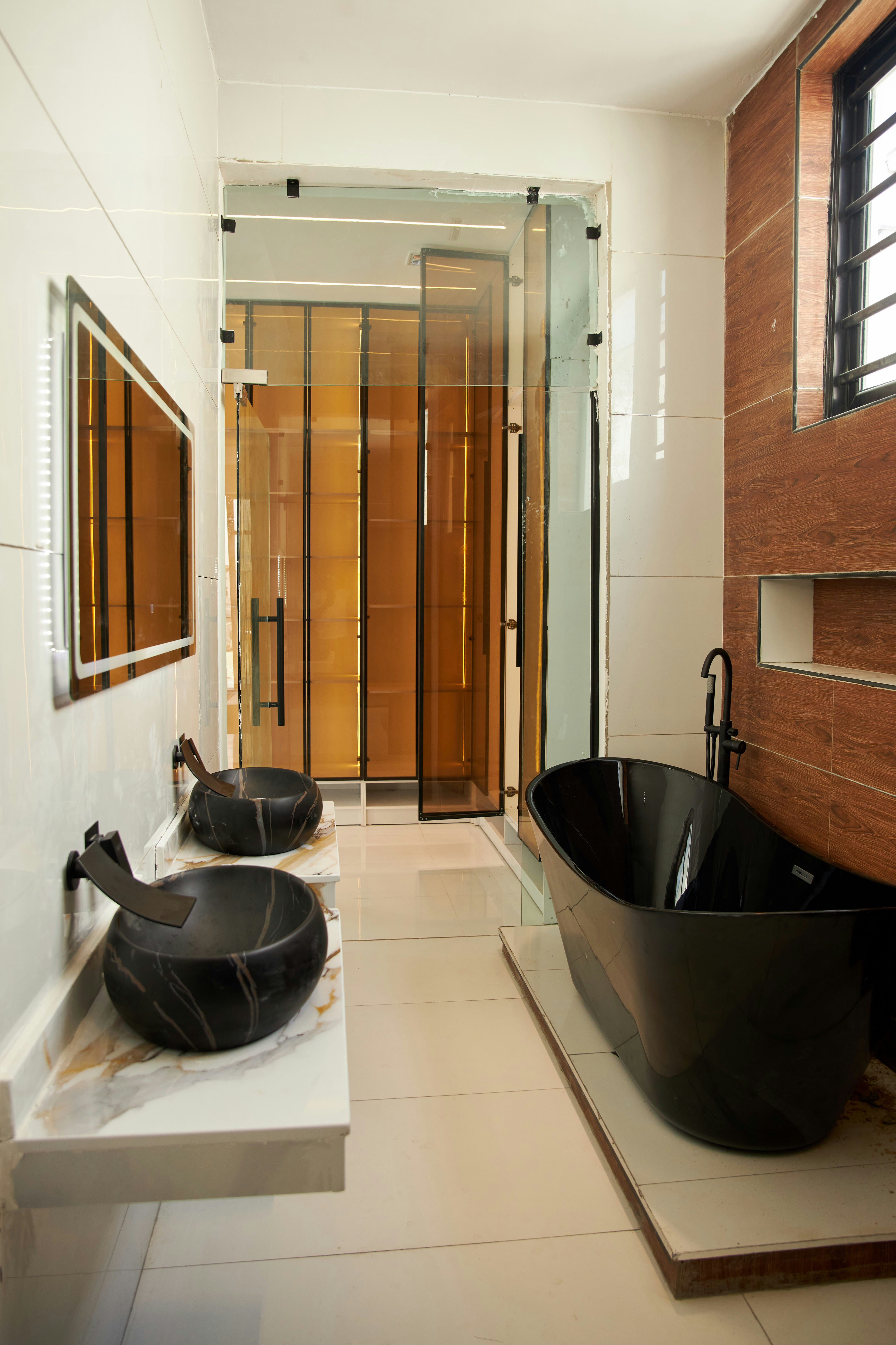 Sleek Soaking Space: Modern Bath with Charcoal Basins