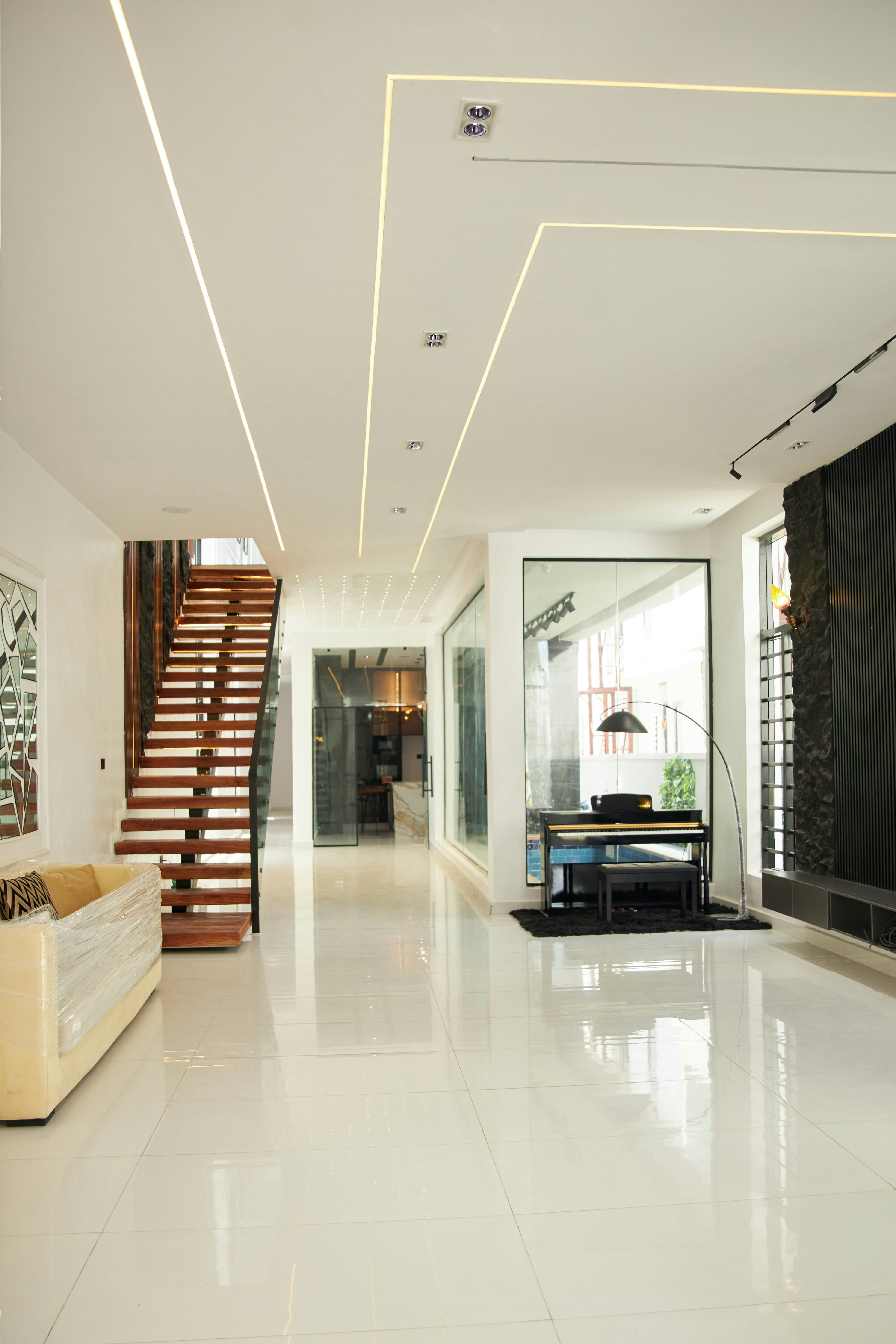 Sunlit Modern Hallway with Grand Stair and Piano Nook
