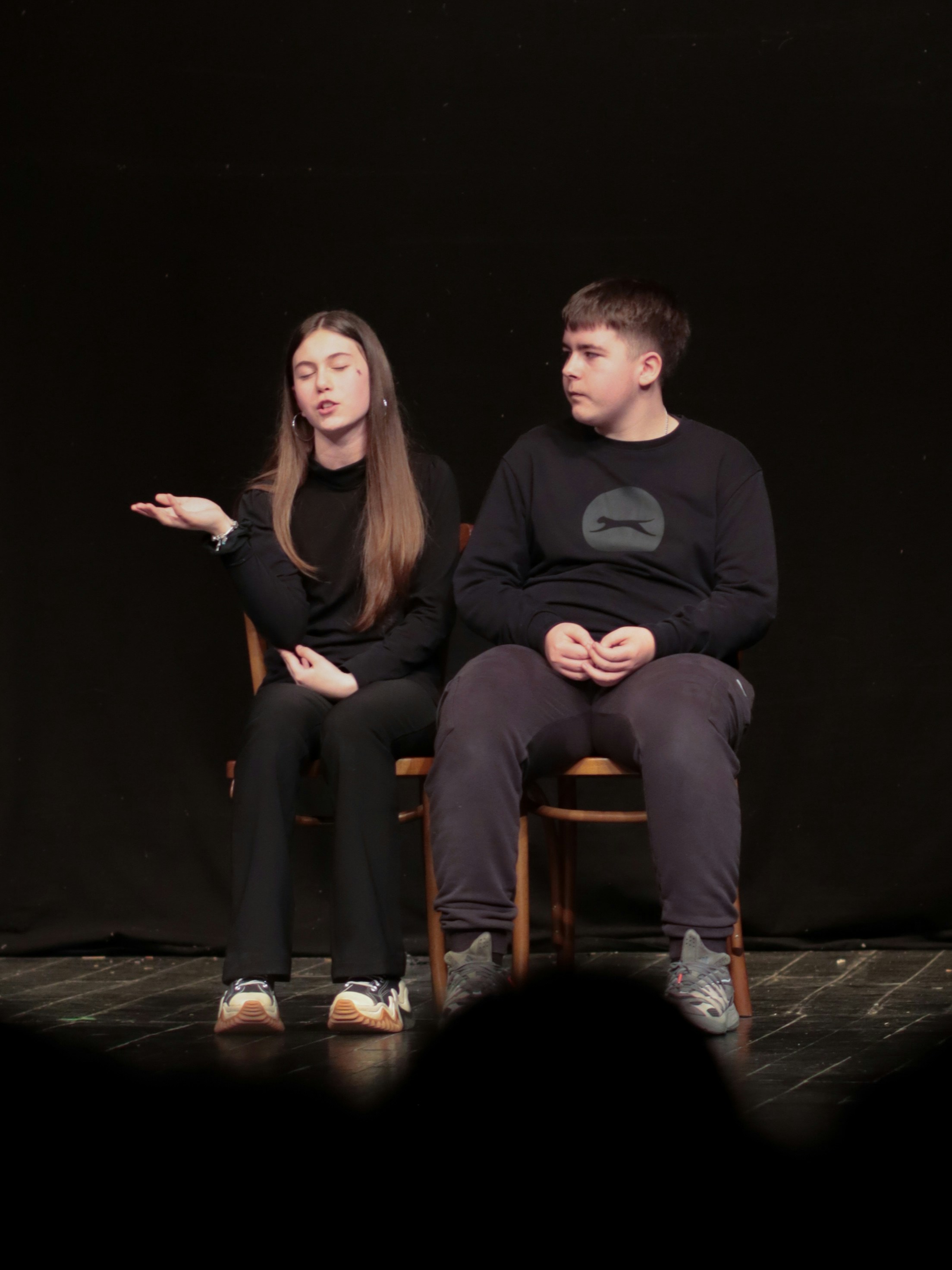 Quiet Exchange on Stage: A Duo in Conversation
