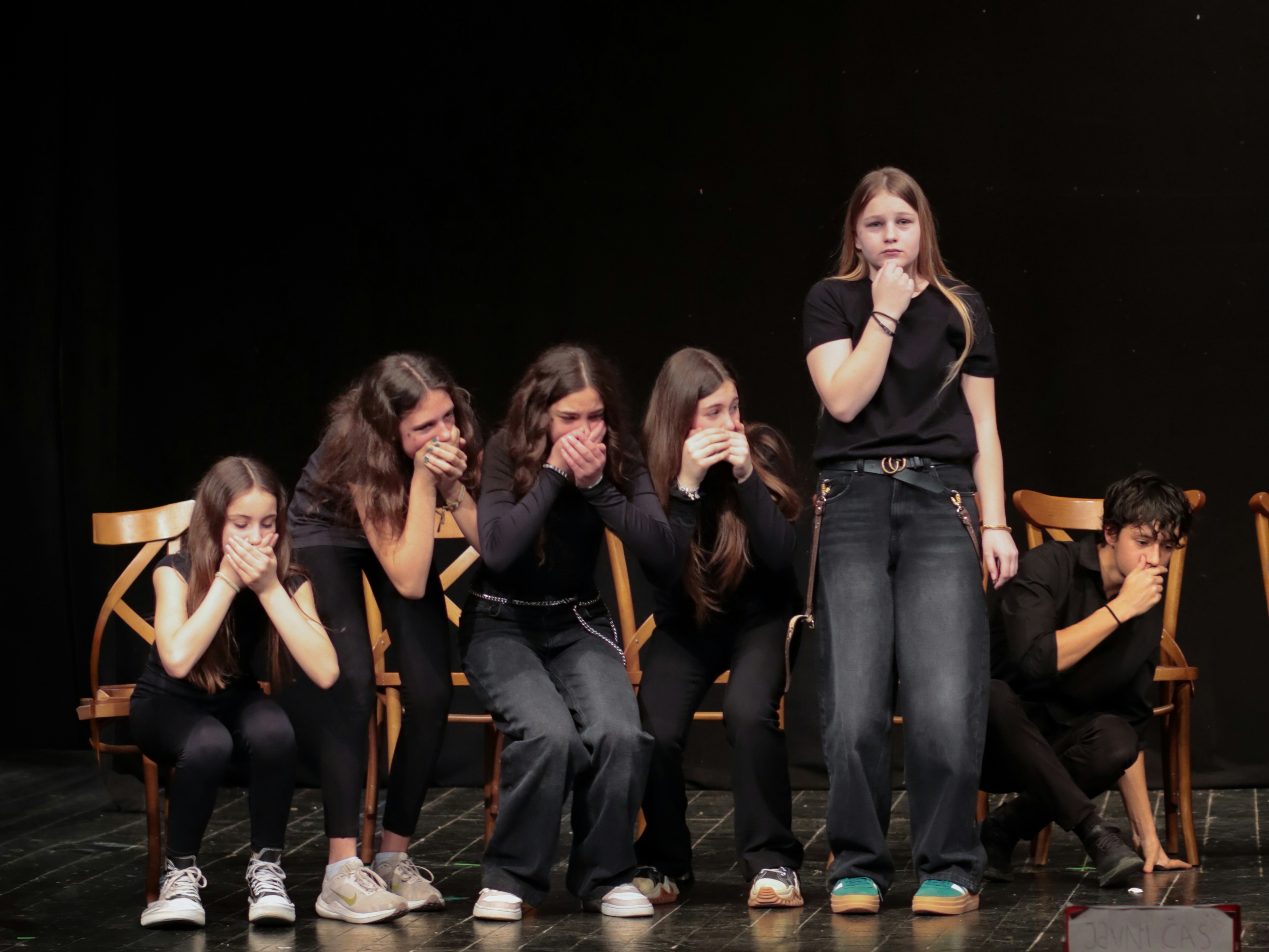 Silent Chorus: A Lineup of Voices in Shadowed Stage Contrast