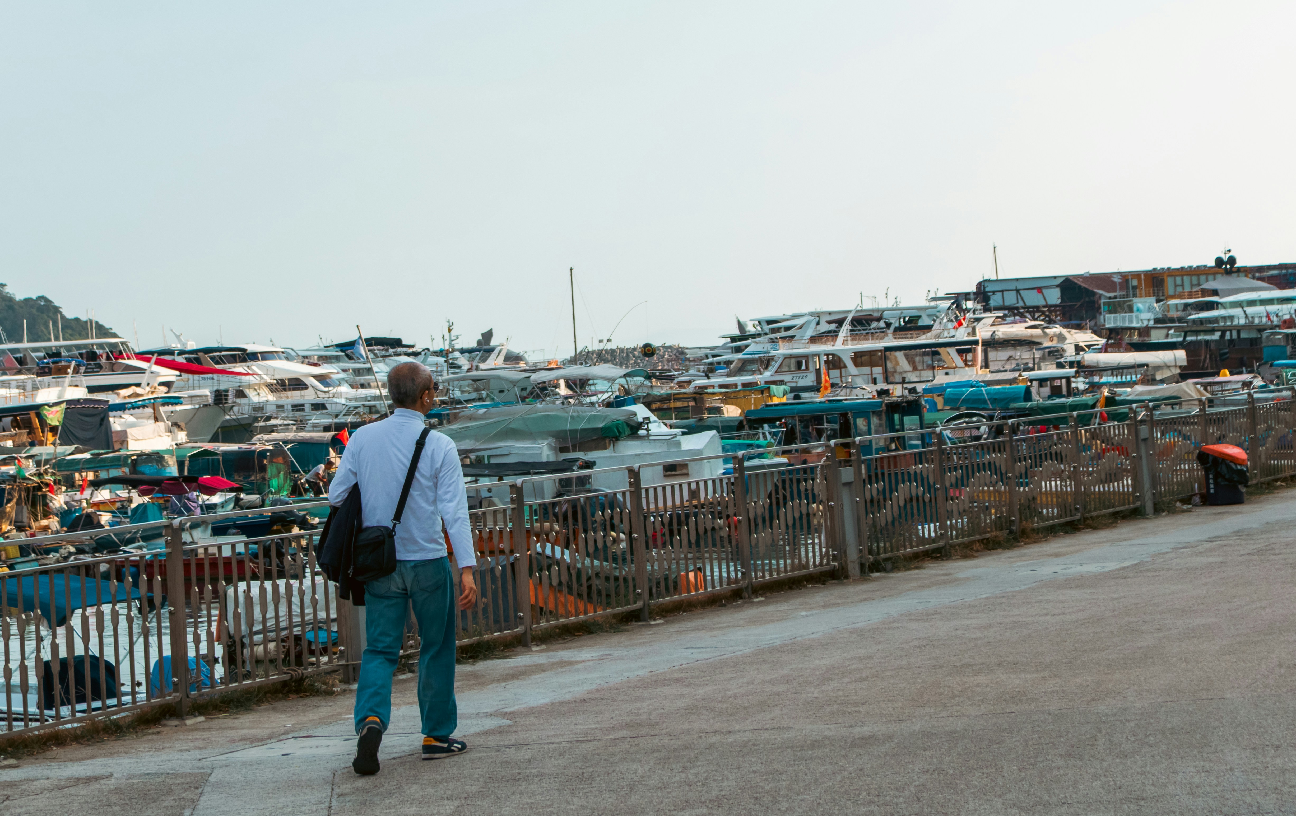 Harbor Walk: A solitary observer among the moored stories