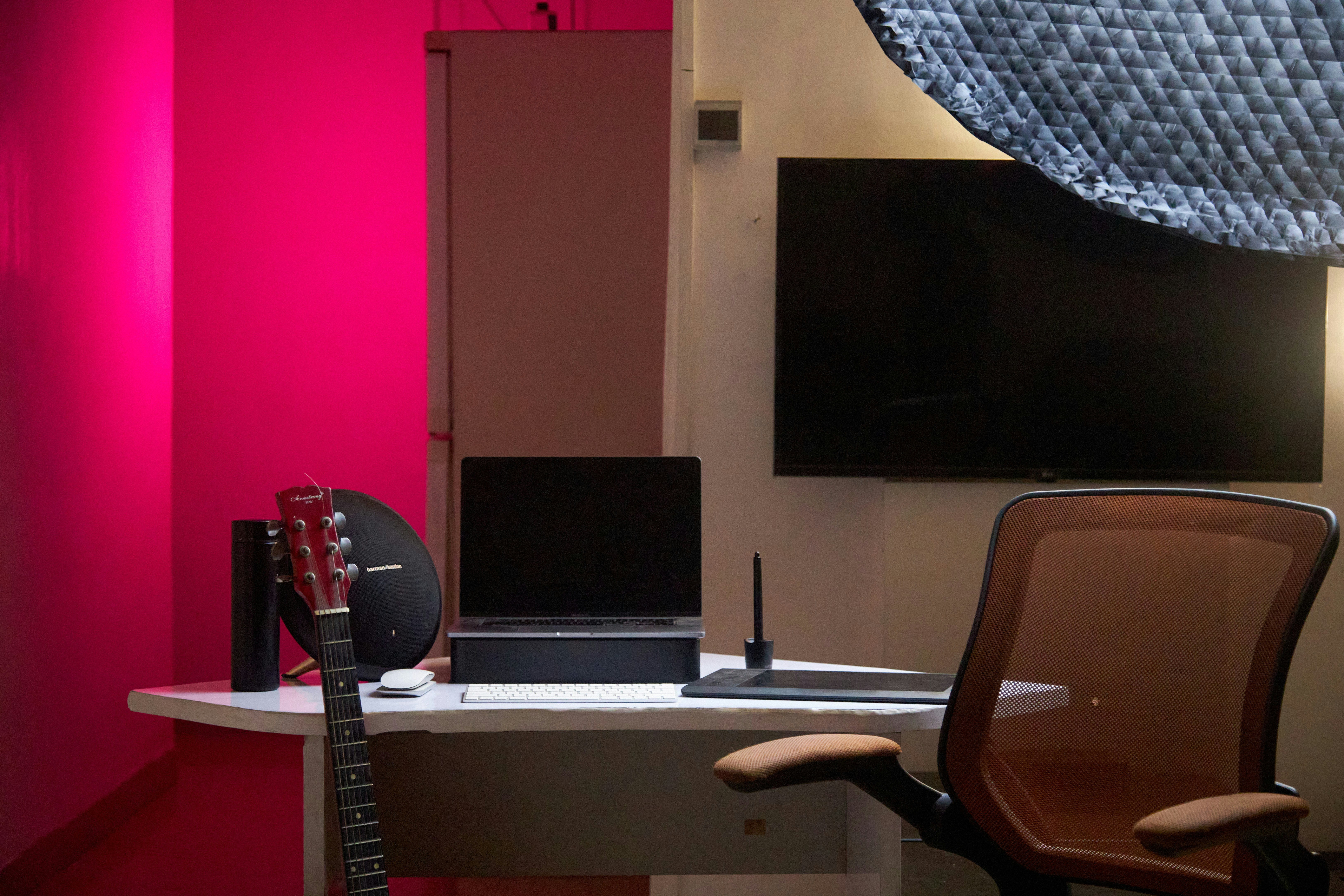 Neon Studio Nook: A Quiet Tech Corner with a Guitar