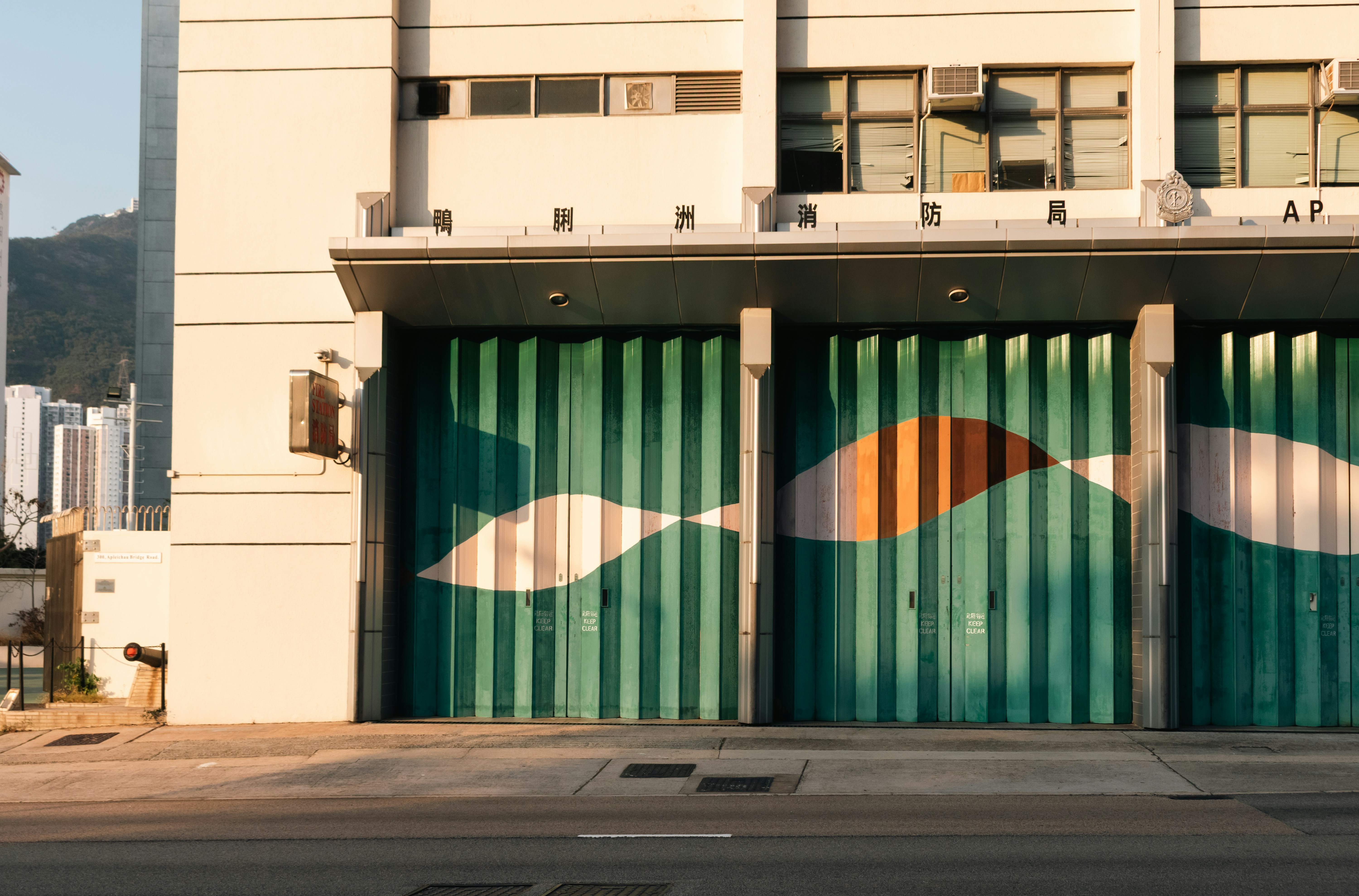 Eye-Level Doors: Three Painted Orbs on a Corrugated Curtain