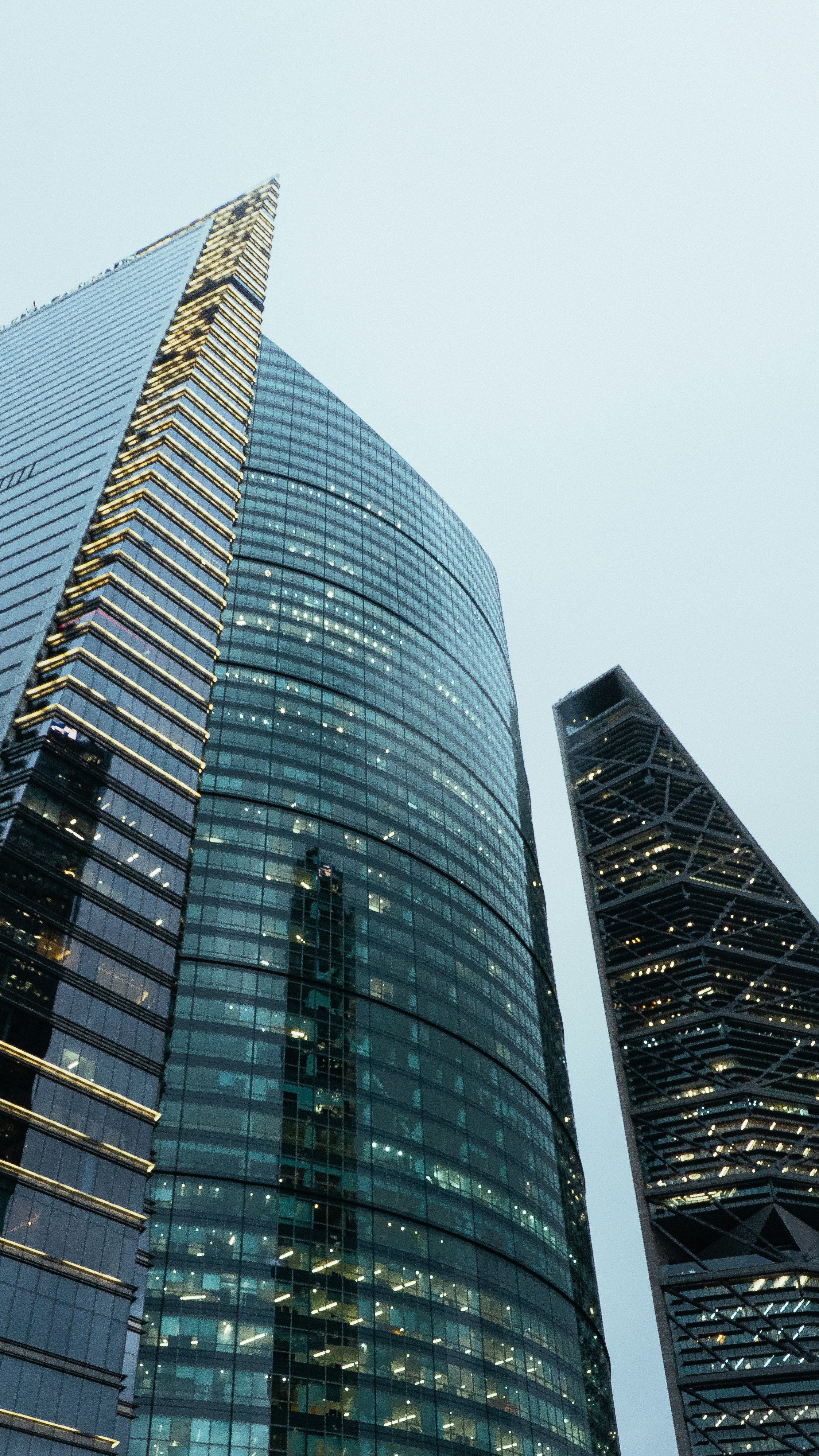 Curved Glass Giants: city towers bending toward the sky