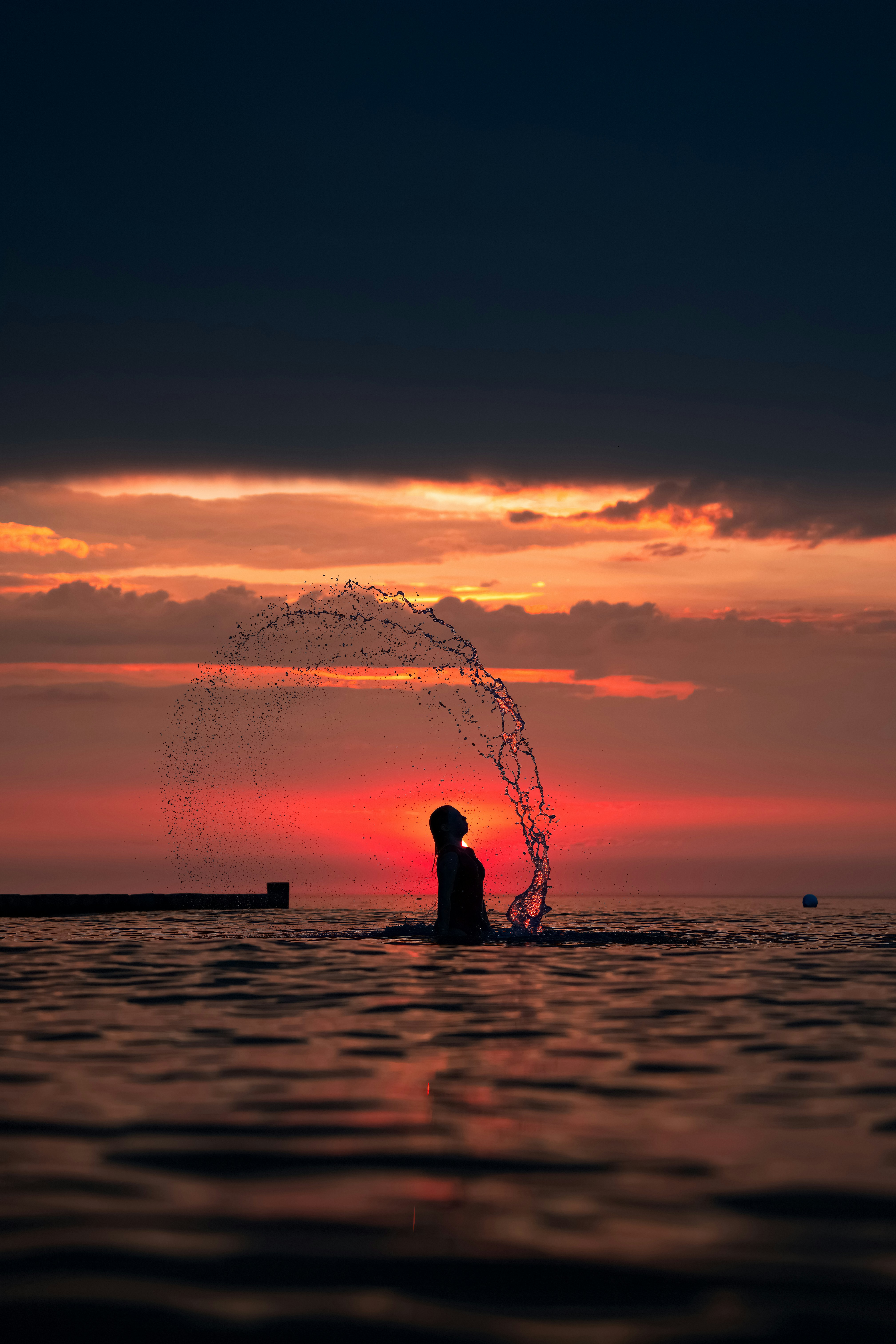 Silhouette at Sunset: A Fountain of Night Water