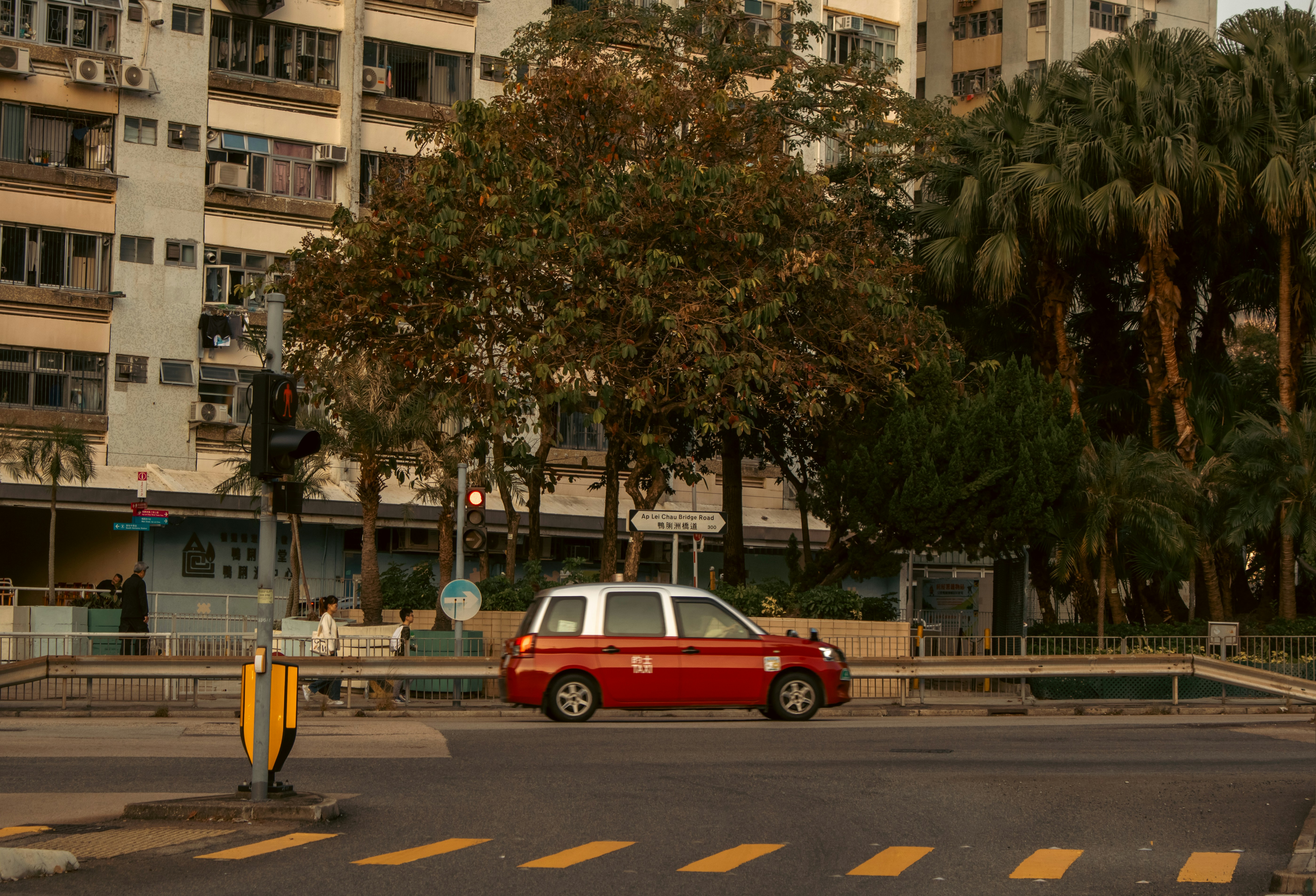 Red Hatchback Crossing: A Quiet Moment at the City Edge