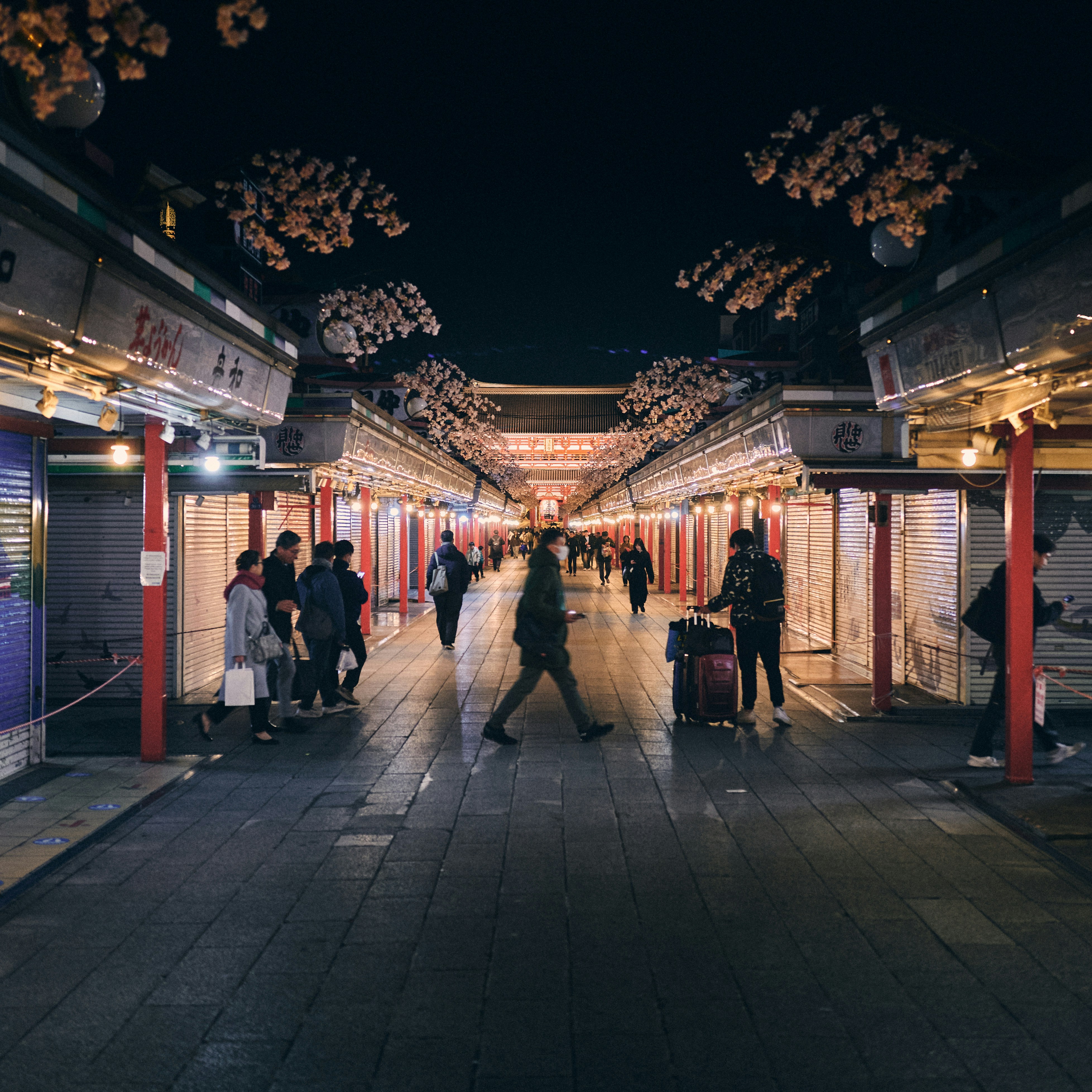 Evening Shopping Arcade: Lanterns, People, and Quiet Motion