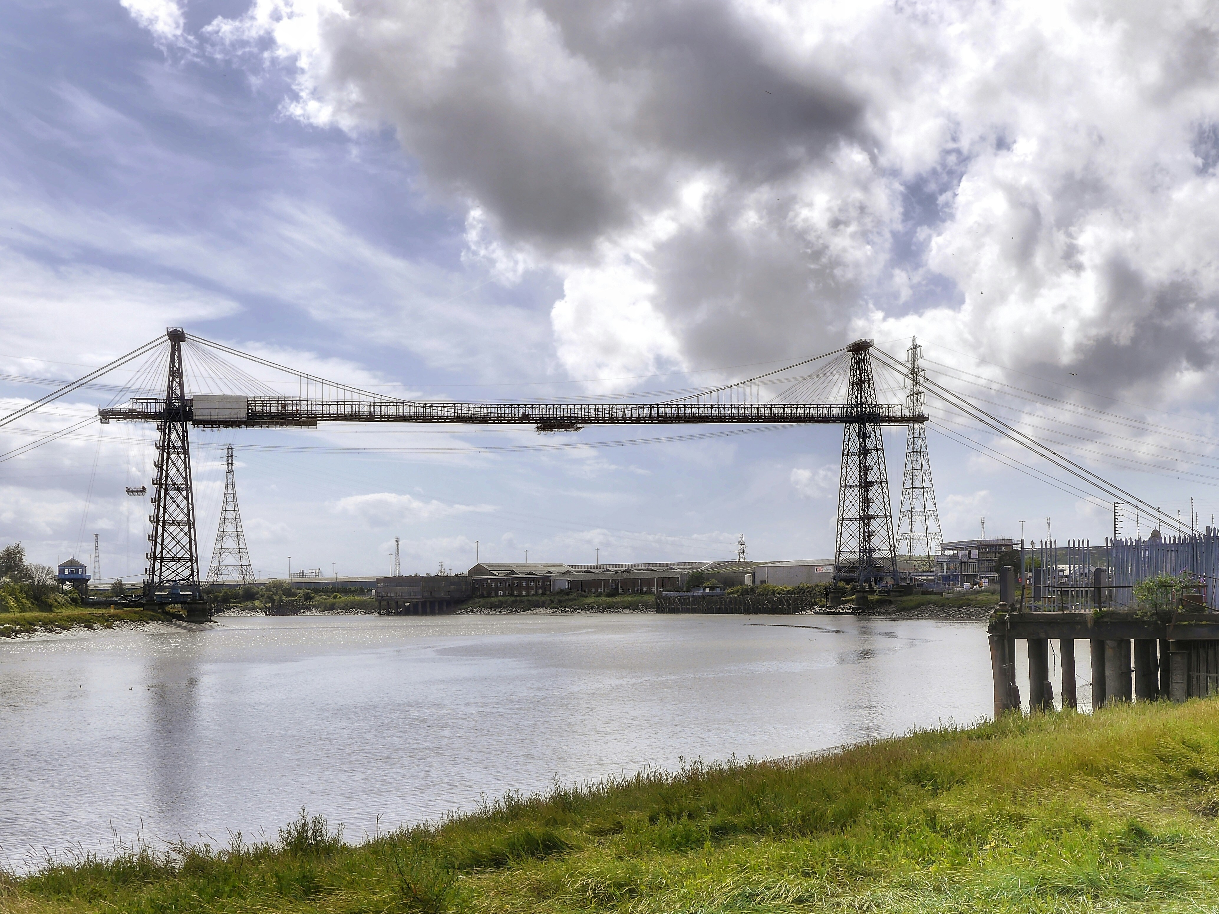 Midday Suspension: A Riverside Span Under Wide Skies