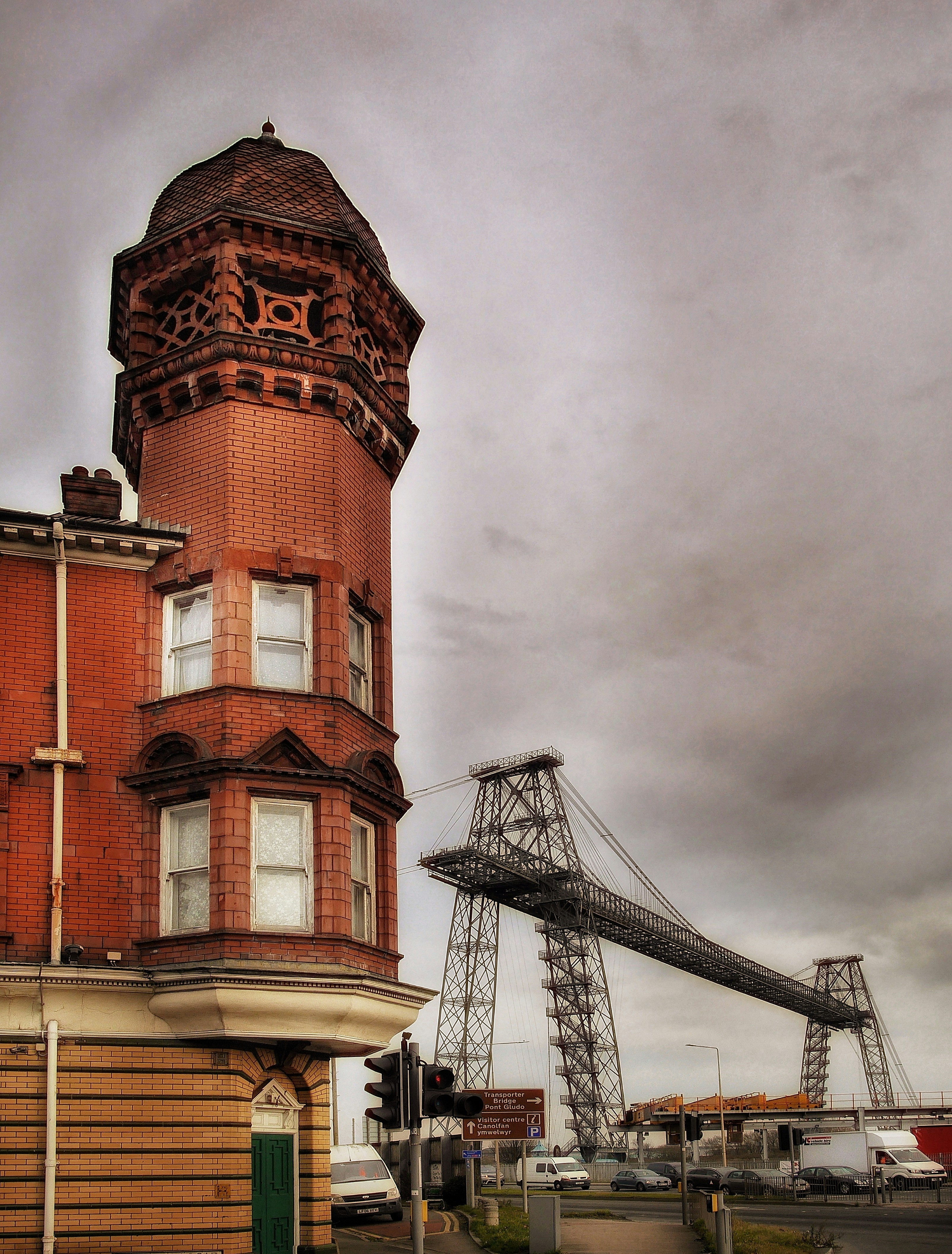 Urban Beacon: A Brick Clocktower Framed by a Industrial Bridge