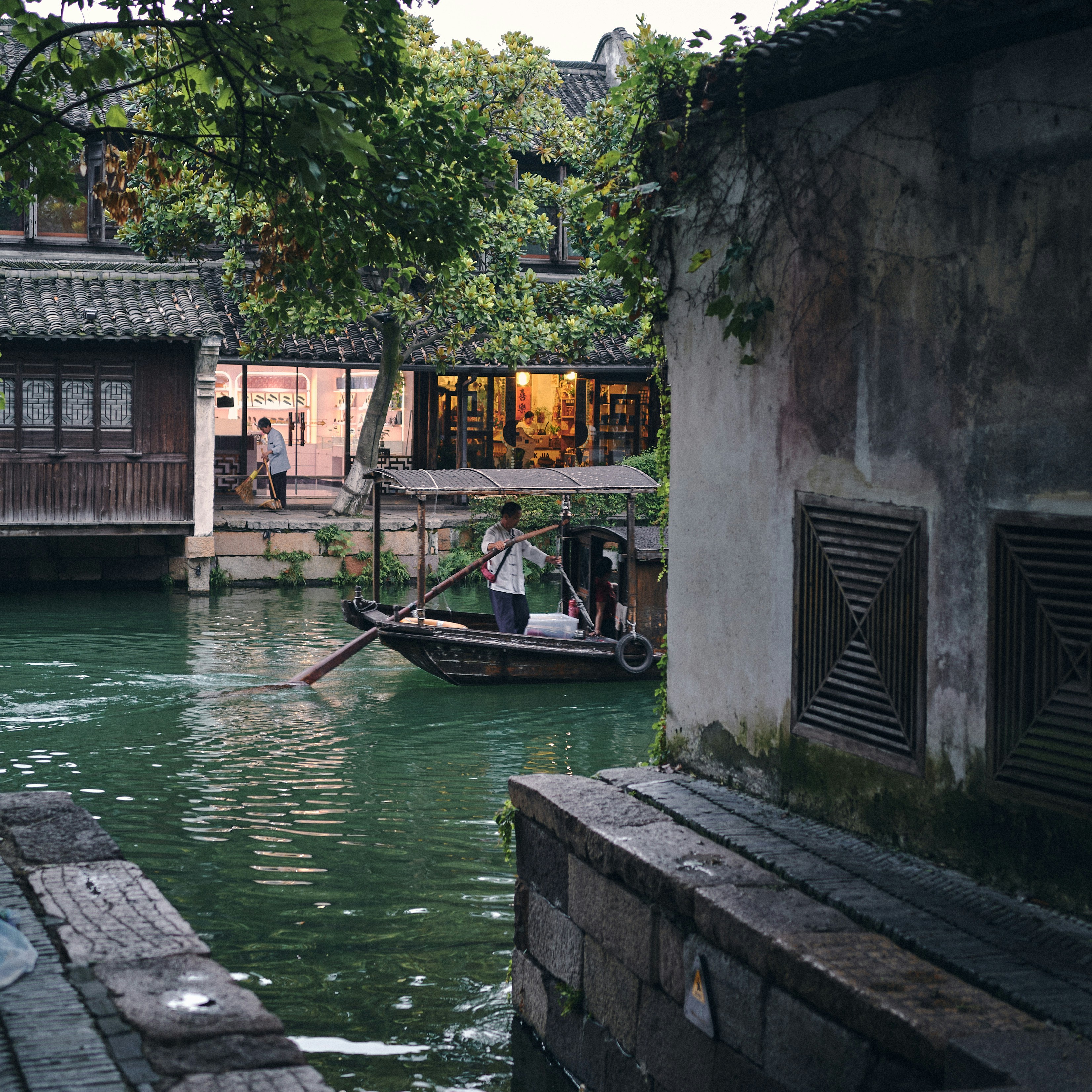 Boatman on a Quiet Canal Between Historic Facades