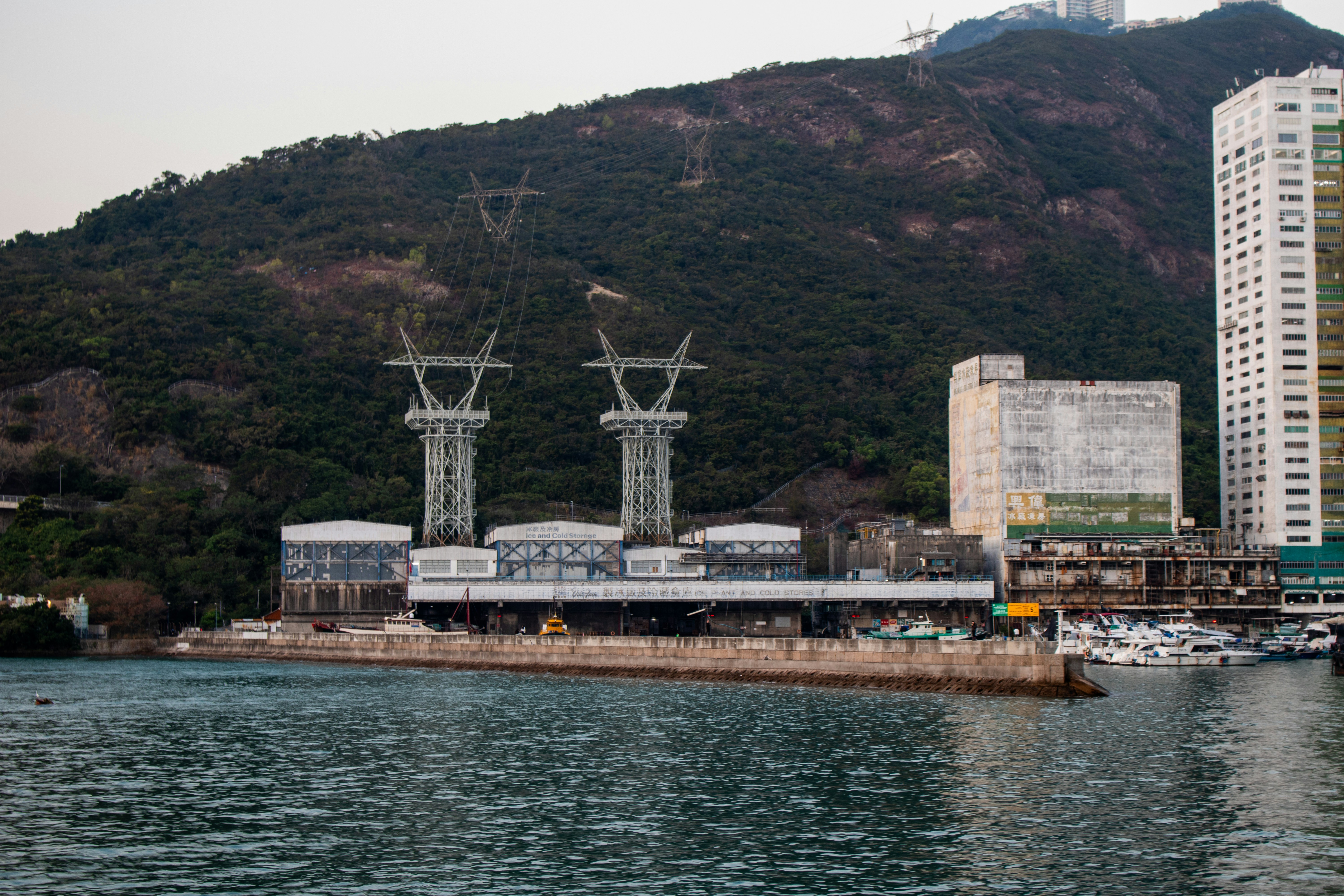 Industrial waterfront under a hillside skyline