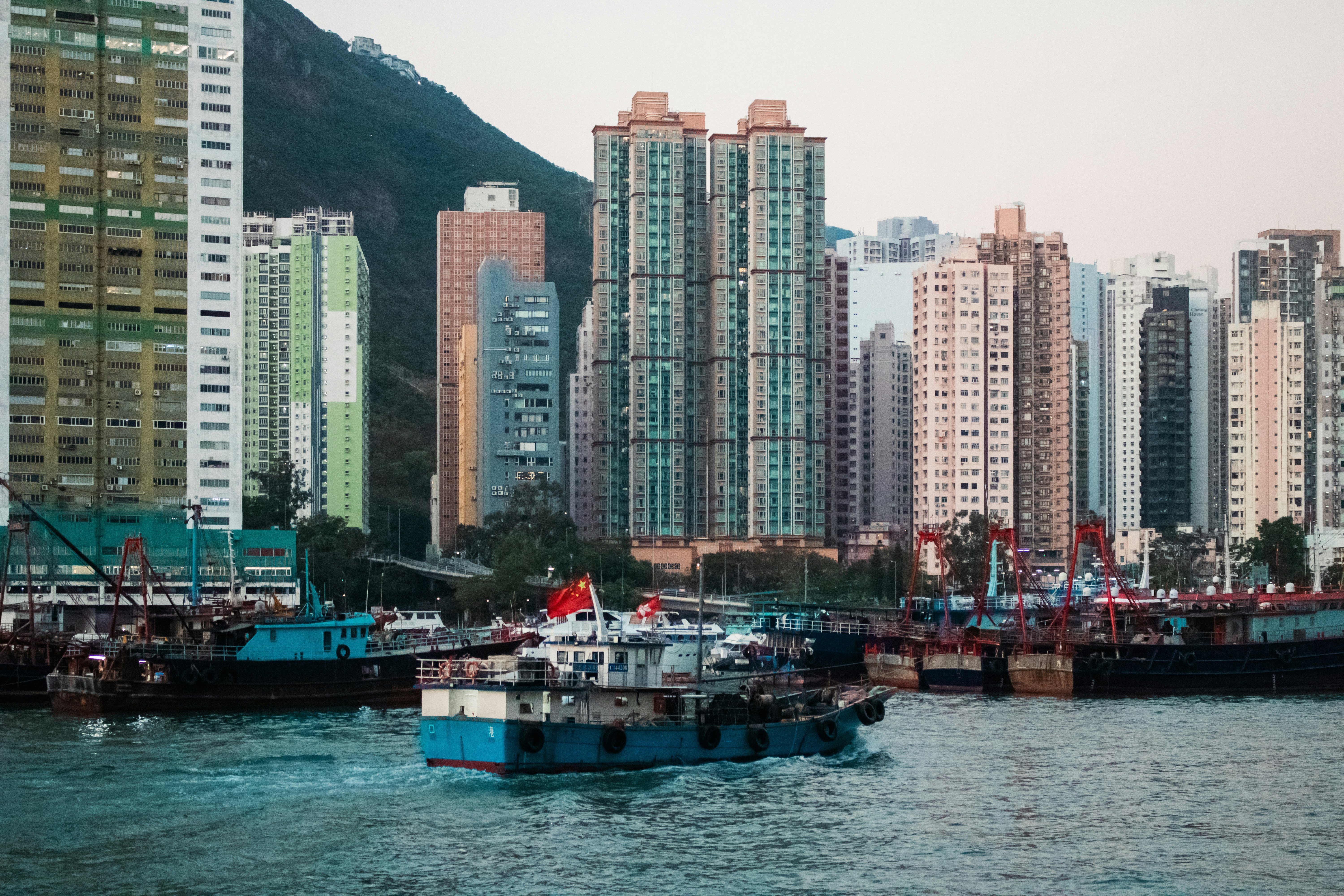 Harbor in Focus: A row of colorful high-rrise facades watching over a working port