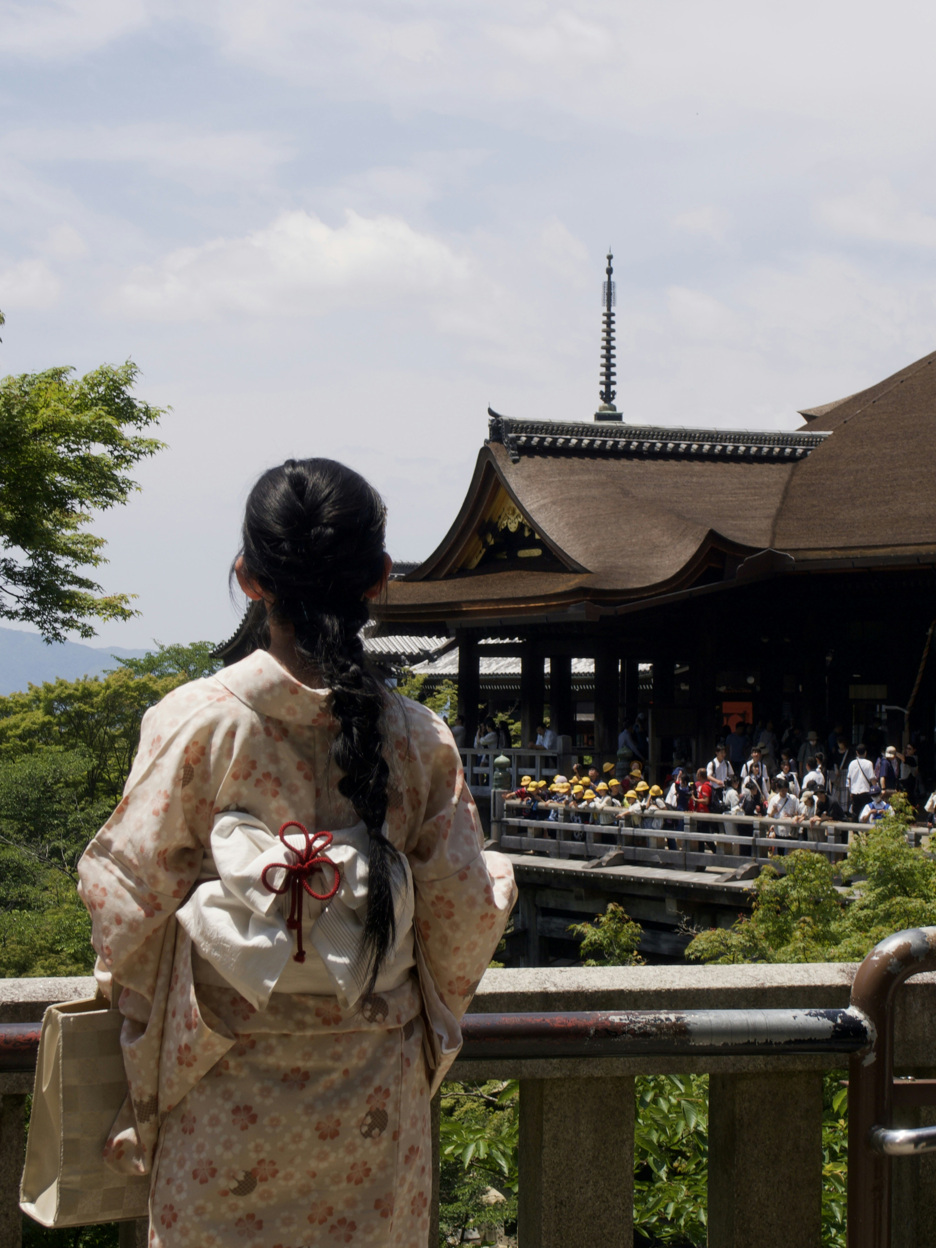 Silent kimono at the ridge: a temple overlook with a braided gaze