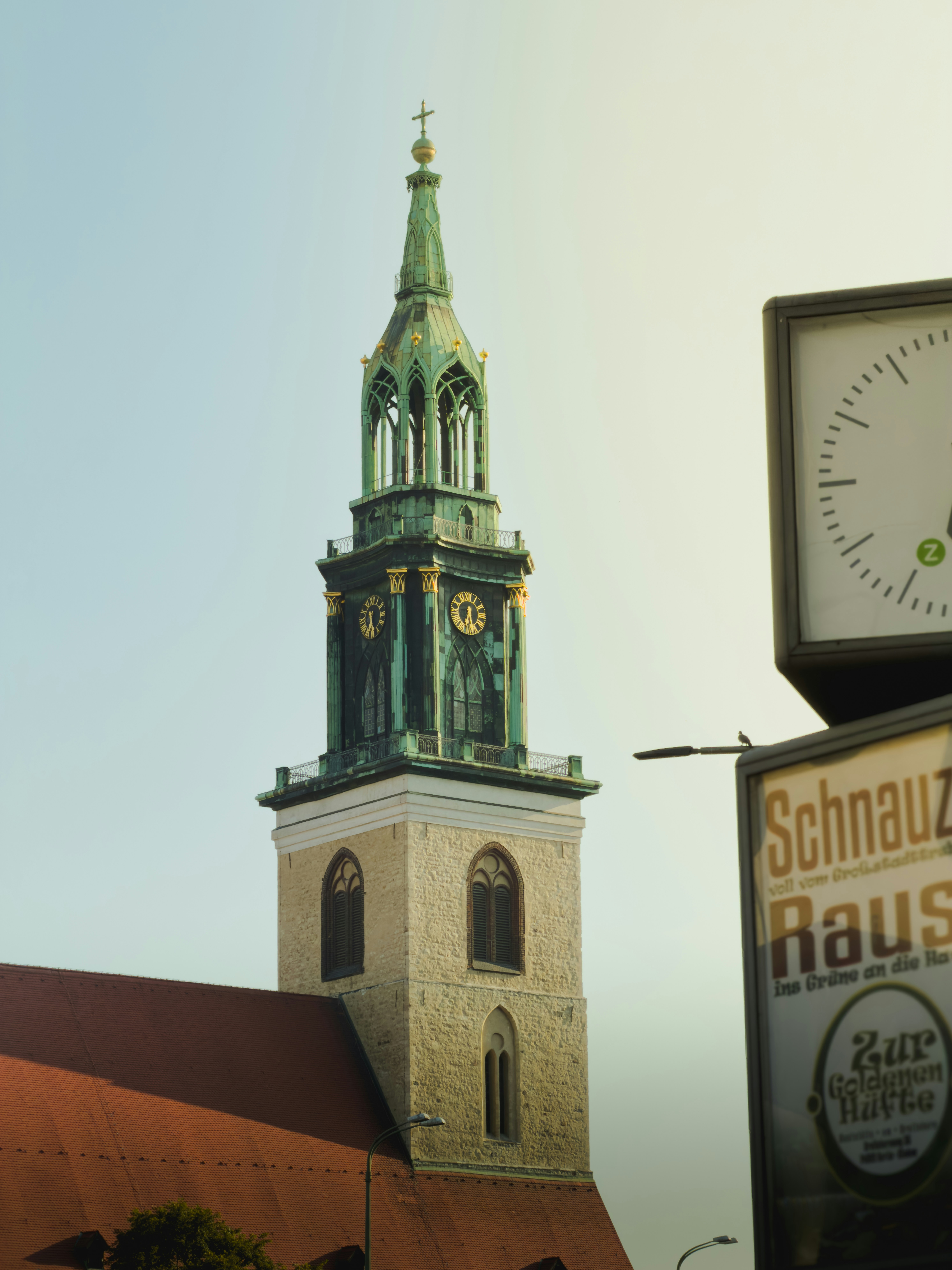 Clocktower Spire Against a Soft Sky with Edge Sign