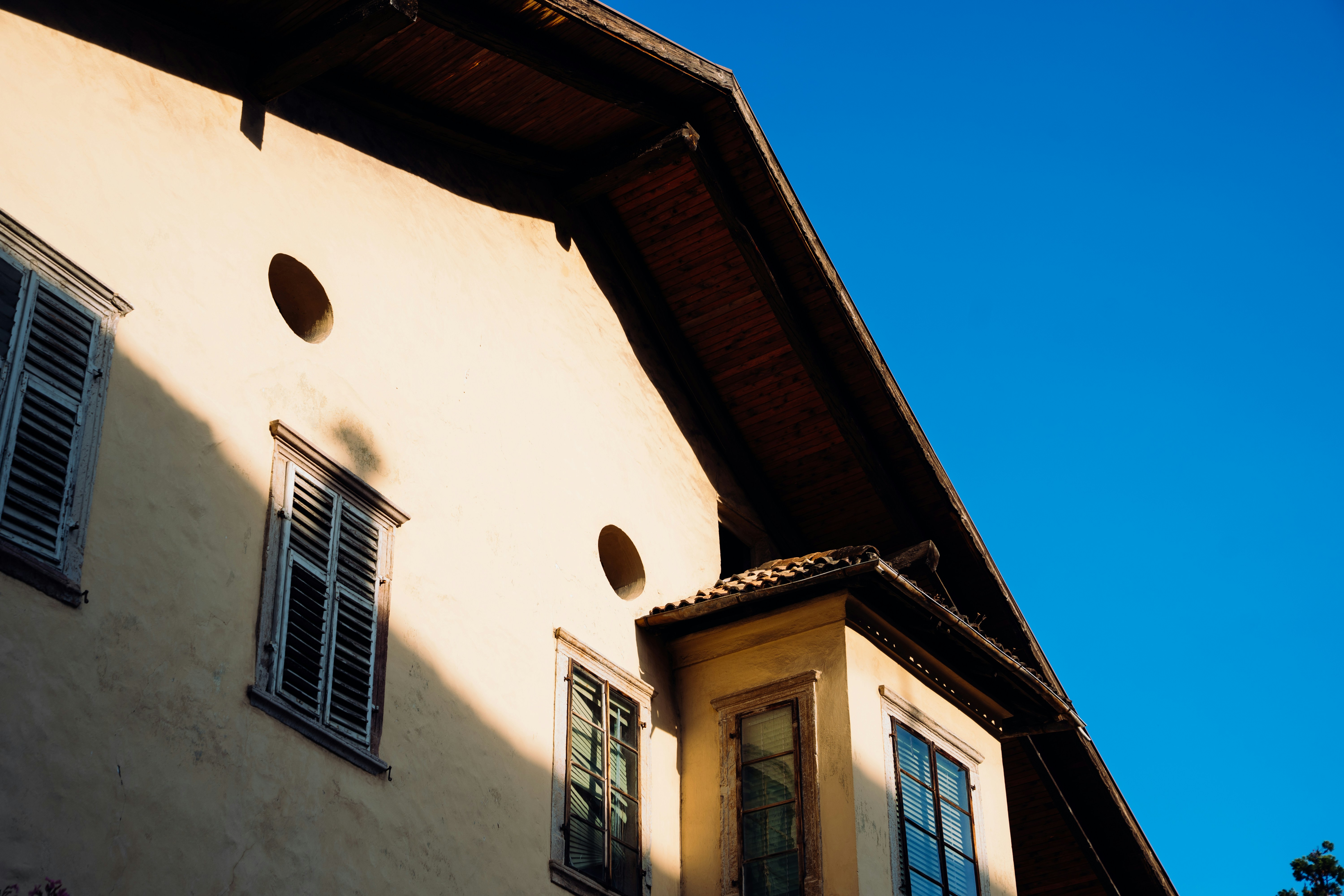 Sunlit Gables and Blue Sky Over a Quiet European House